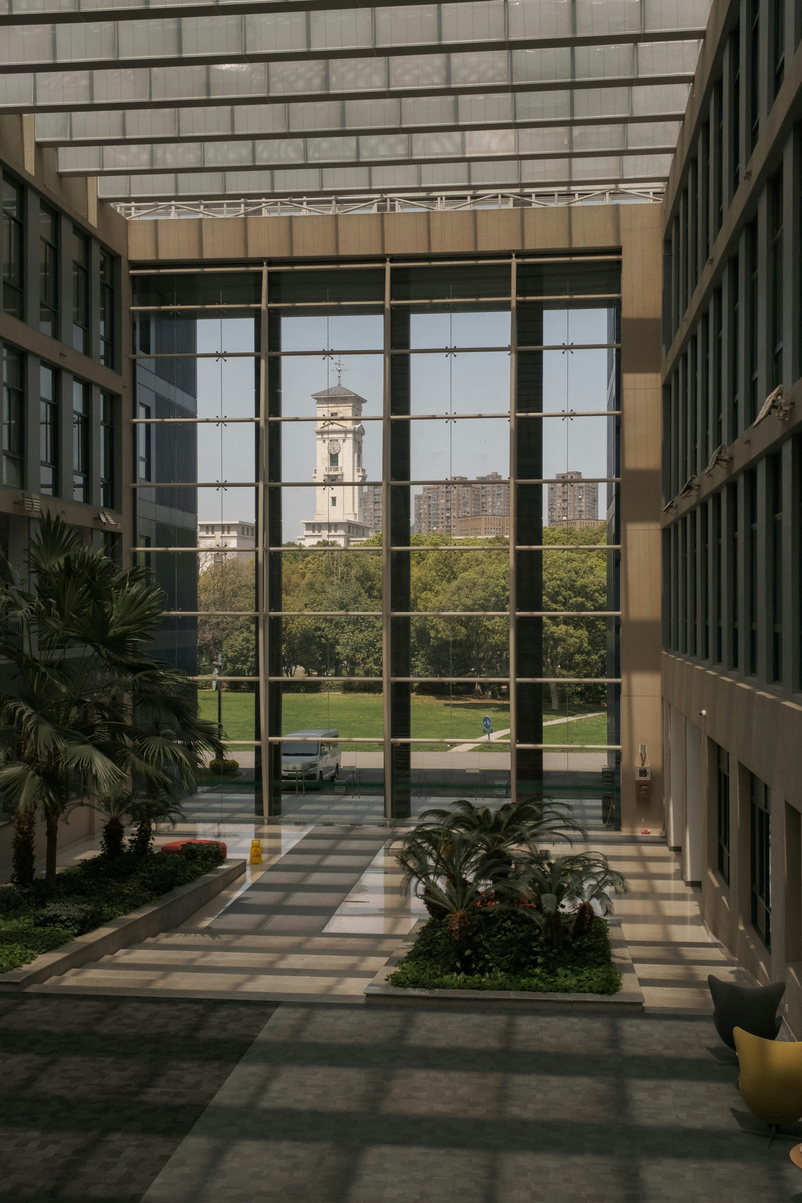 Glass-Walled Atrium Framing a Clock Tower