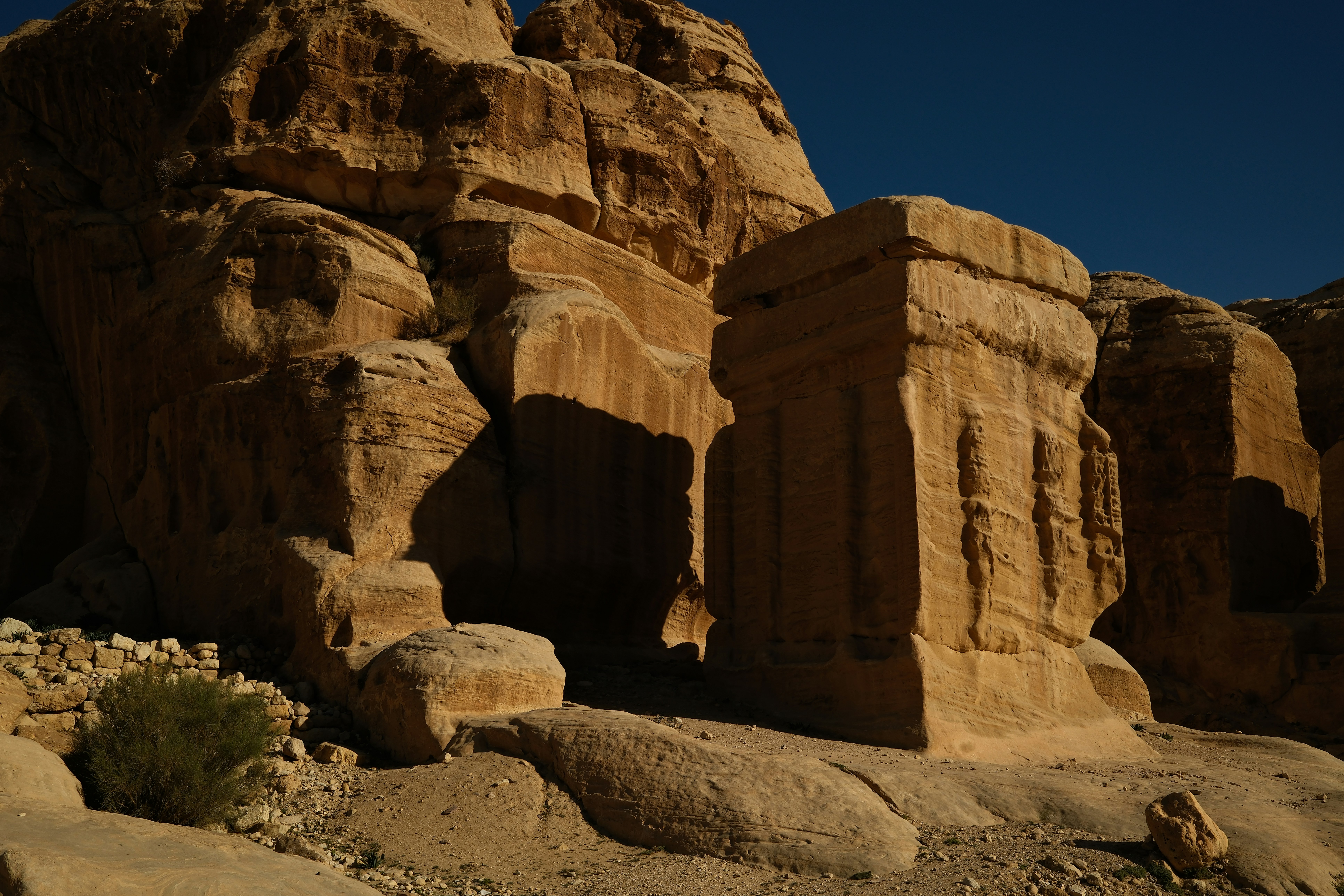 Monolithic Echoes: A Carved Pillar Standing Against the Desert Sky