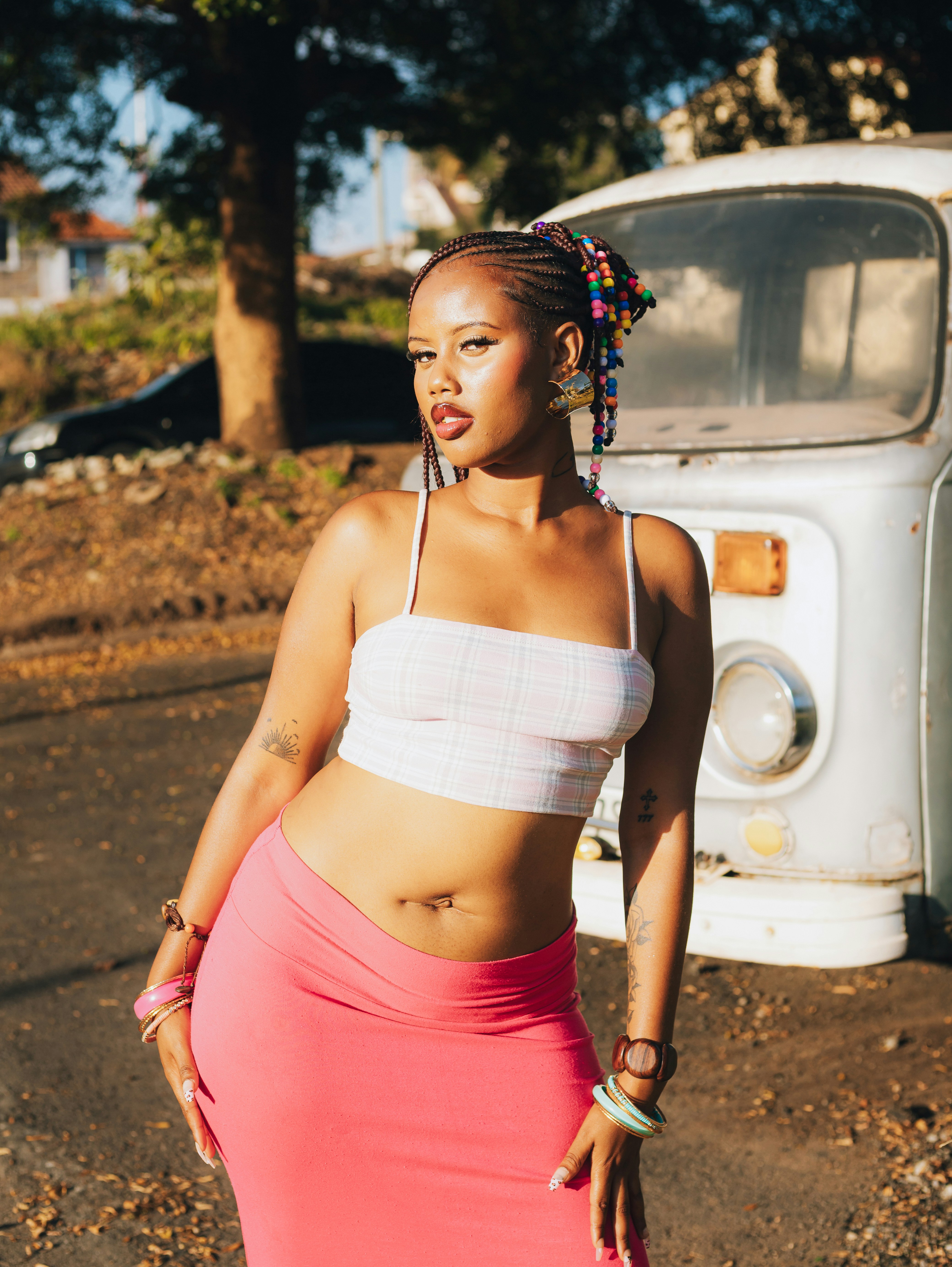 Braided crown and sunlit confidence in front of a vintage van