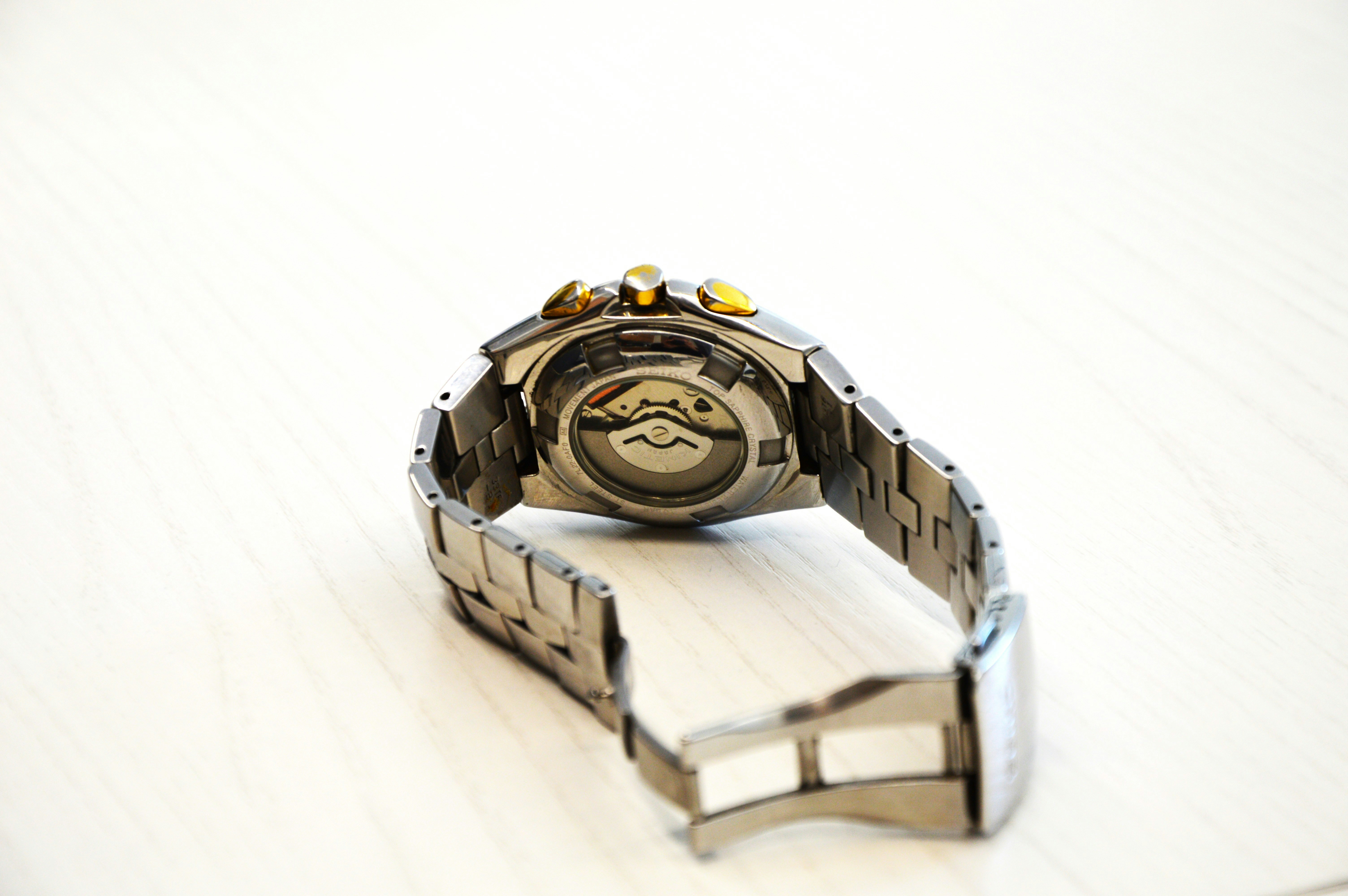 Disassembled Timekeeper: A Metal Bracelet Reposes with Back Case Hidden