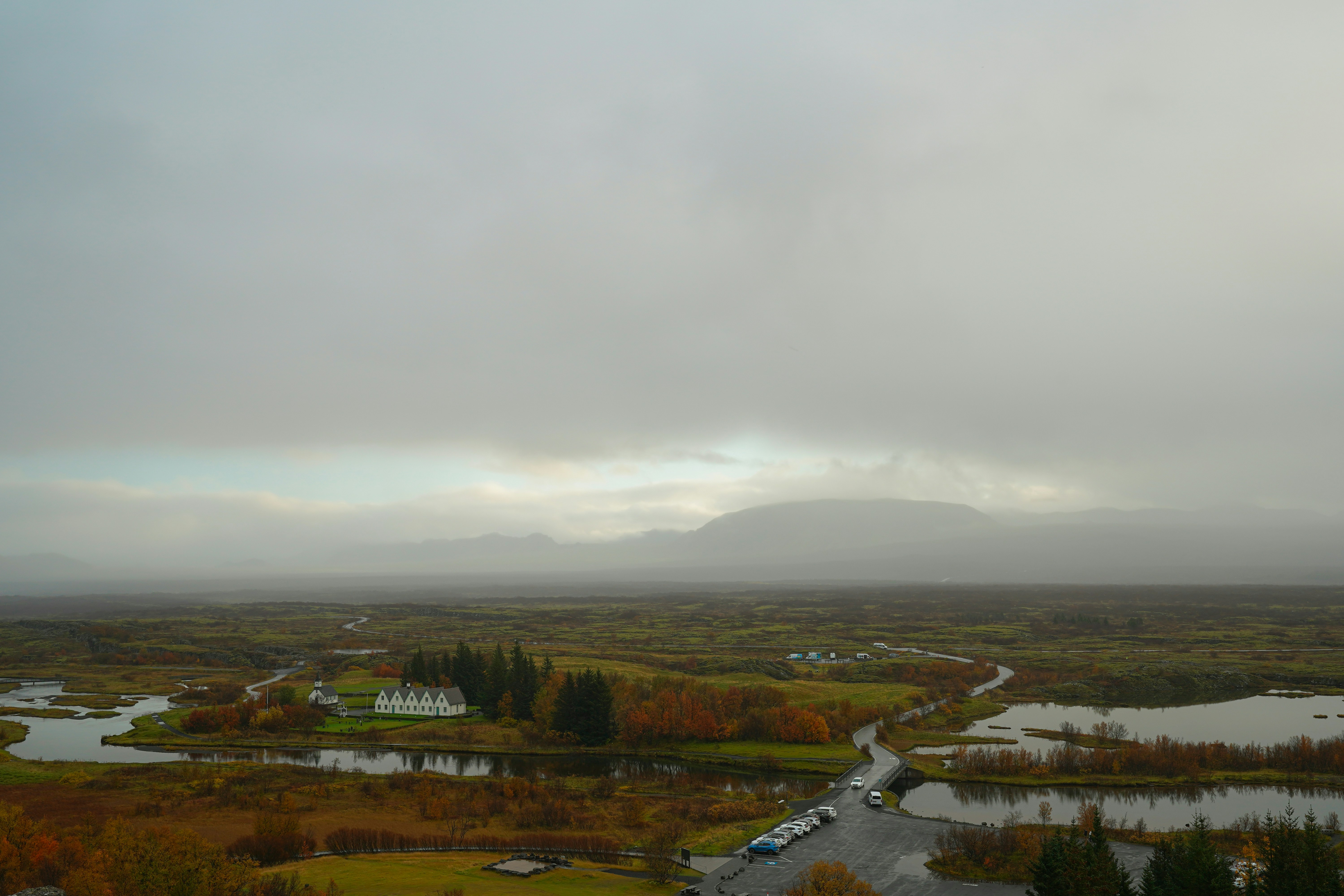Misty Lowland Reach: Autumn Fields Near a Quiet Road