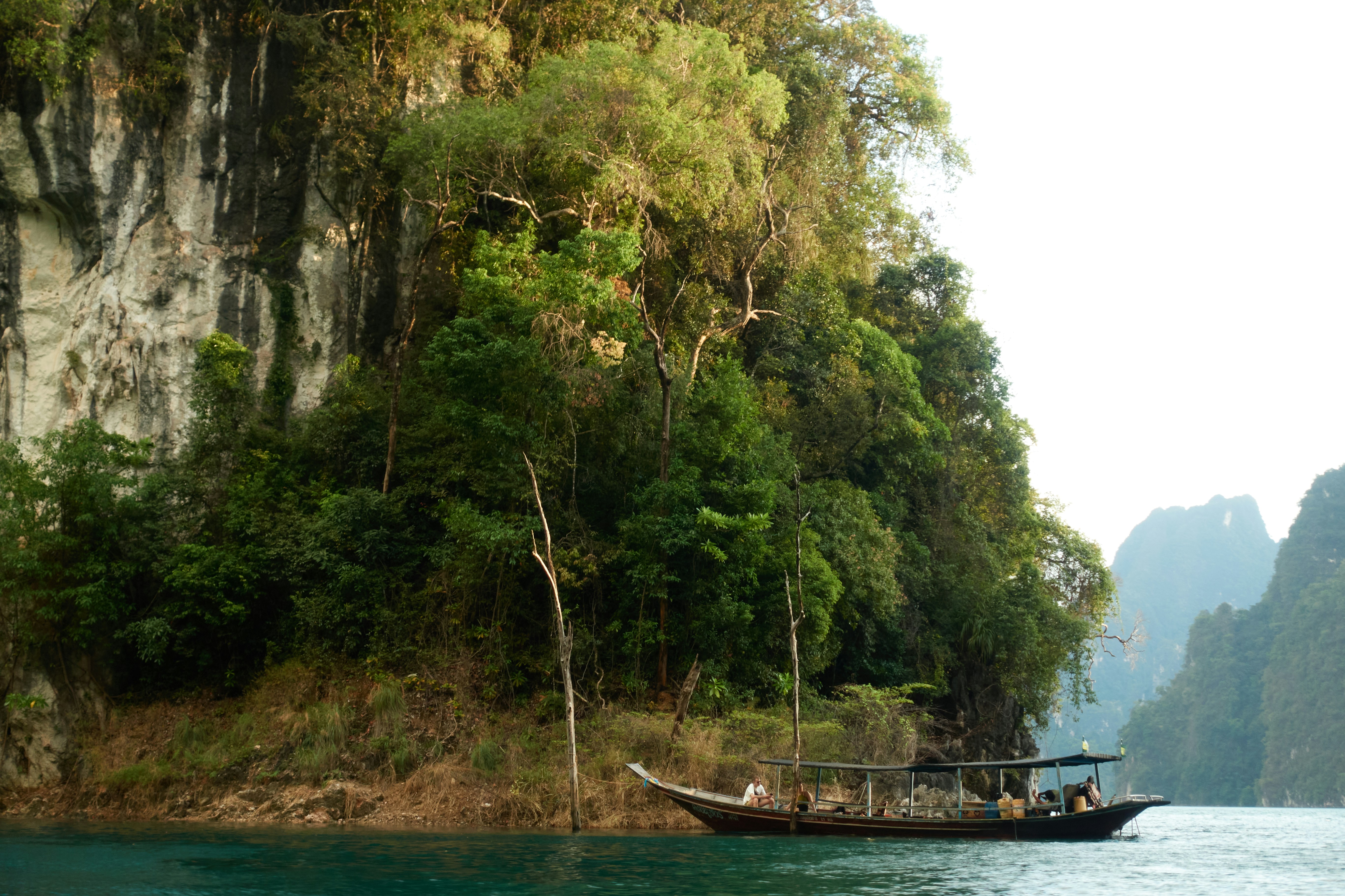 Boat Silhouette Beneath Towering Limestone Cliffs at Emerald Bay