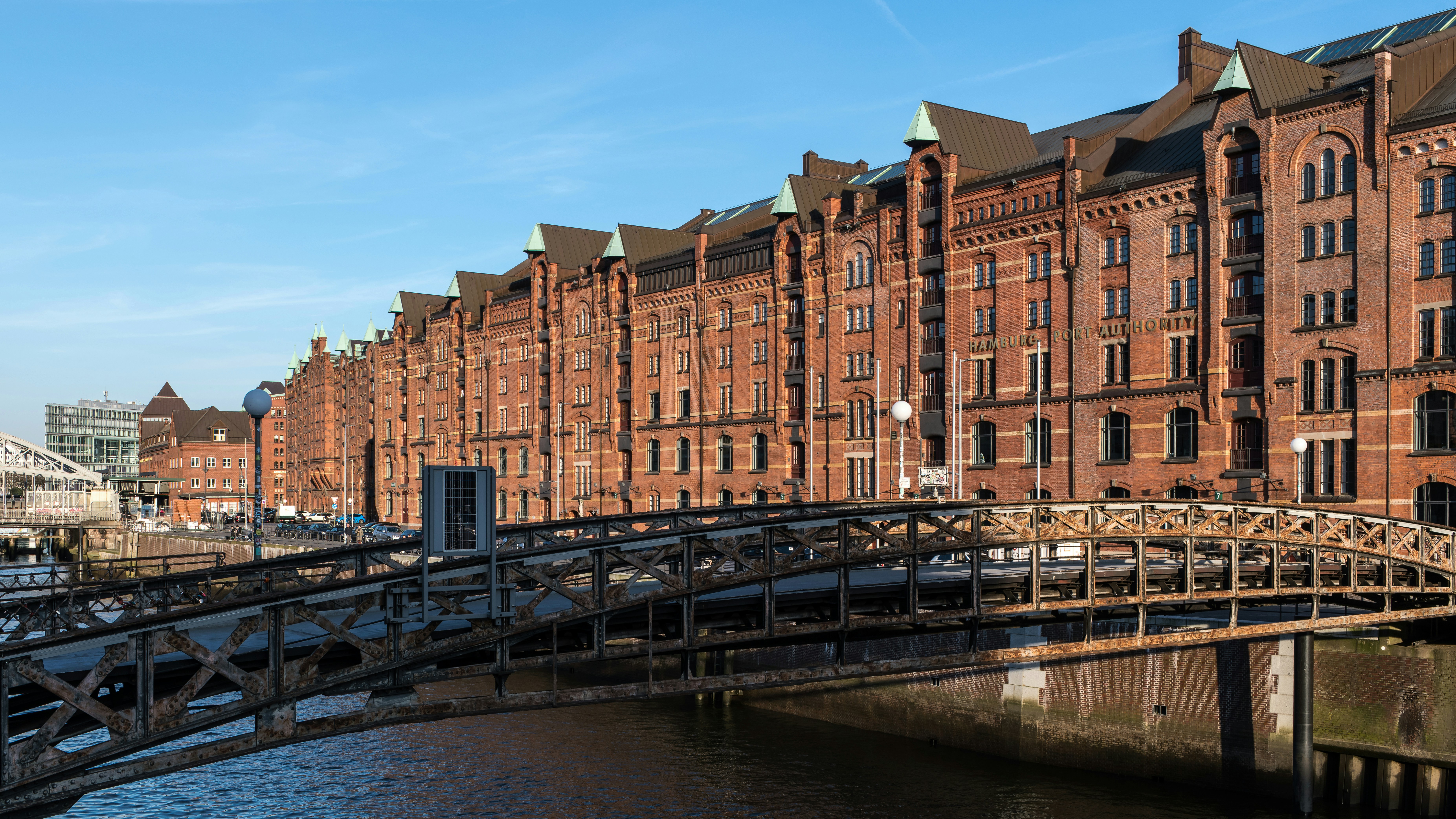 Brickline along the River: A City Block Framed by a Timber-Bridge