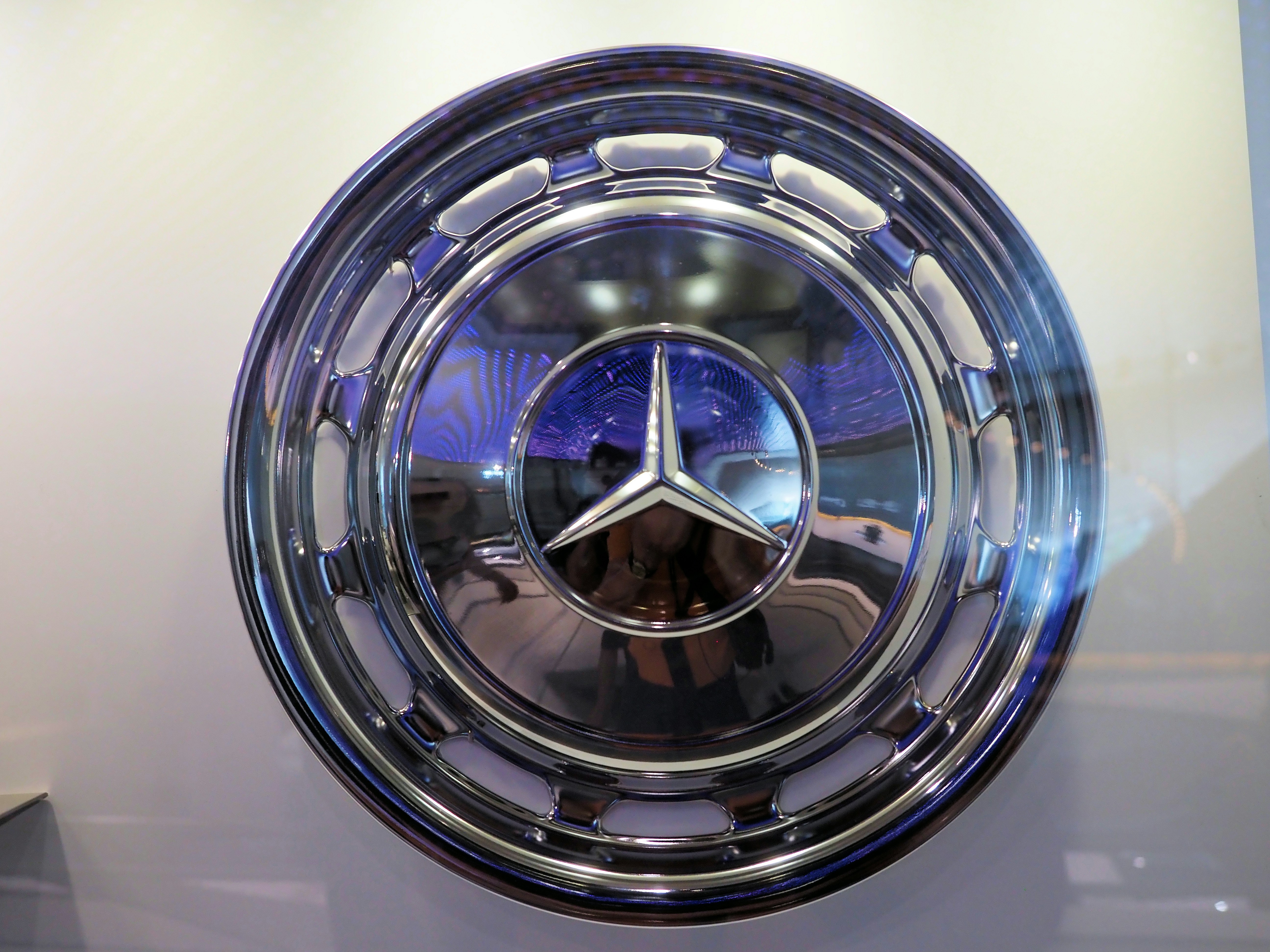 Chrome Crest: A Mercedes-Benz emblem mirrored in a polished hub