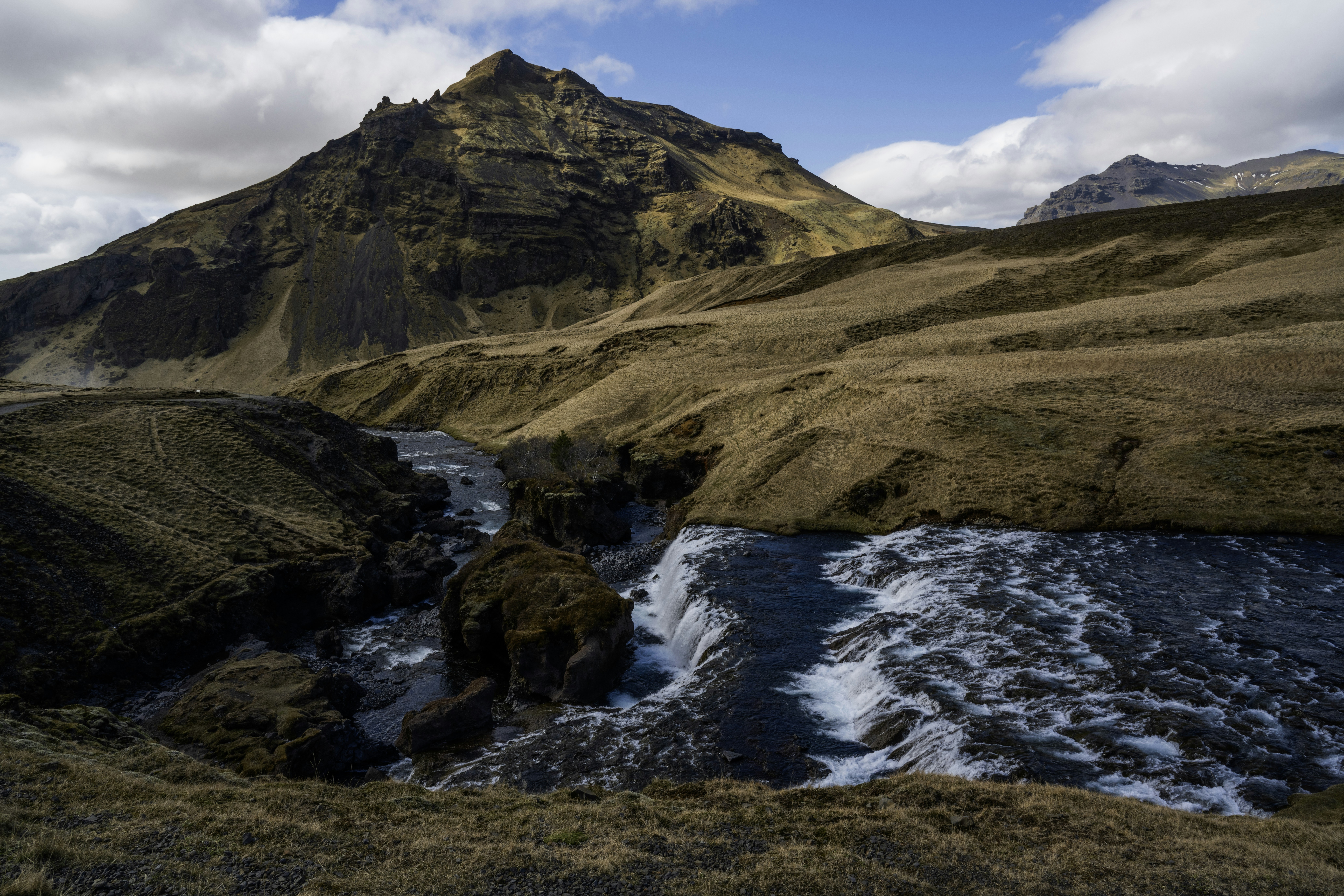 Rugged Coastal Ridge: A River Cuts Through the Moor Under a Blue Sky