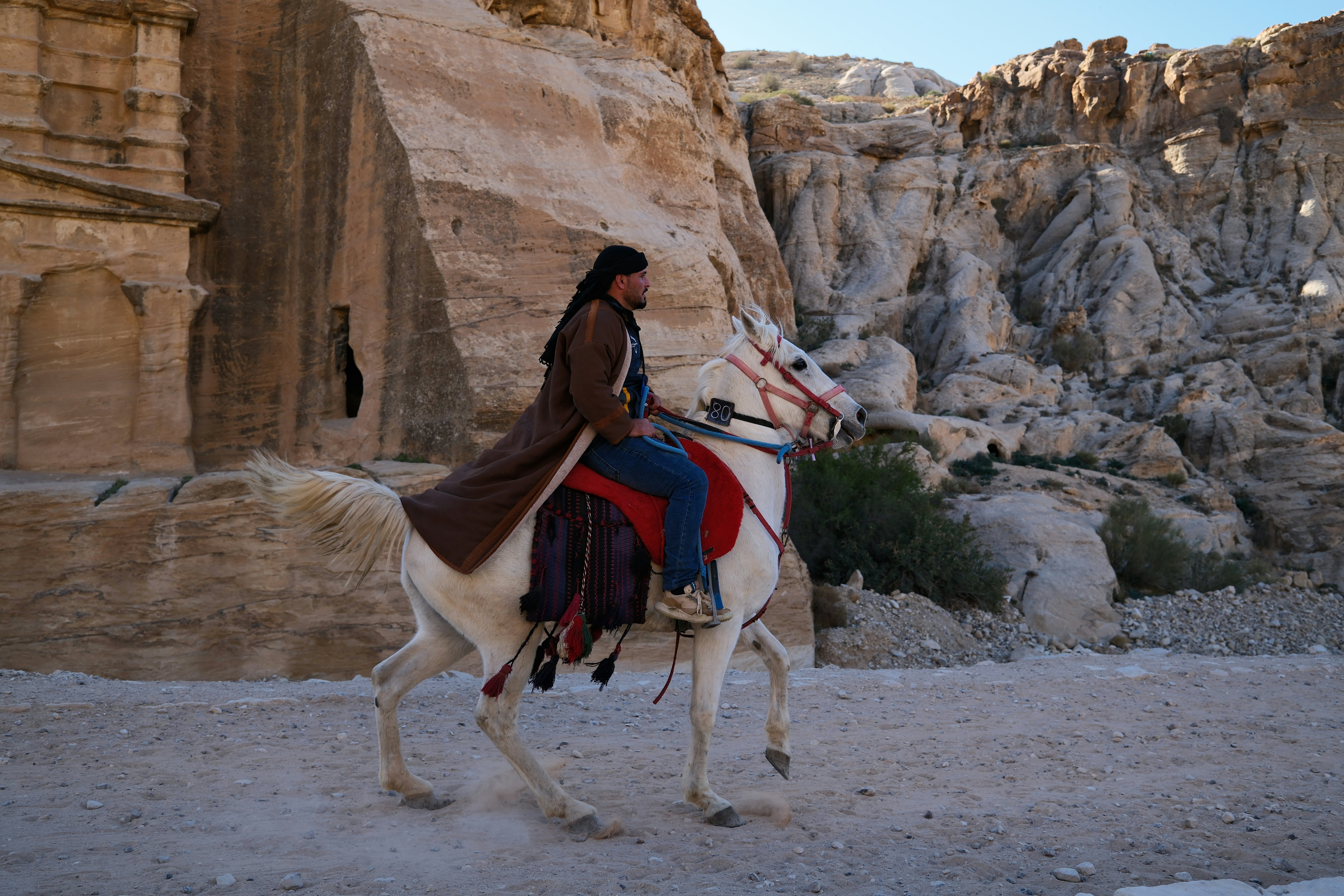 Mounted Rider Against Ancient Canyon Facade