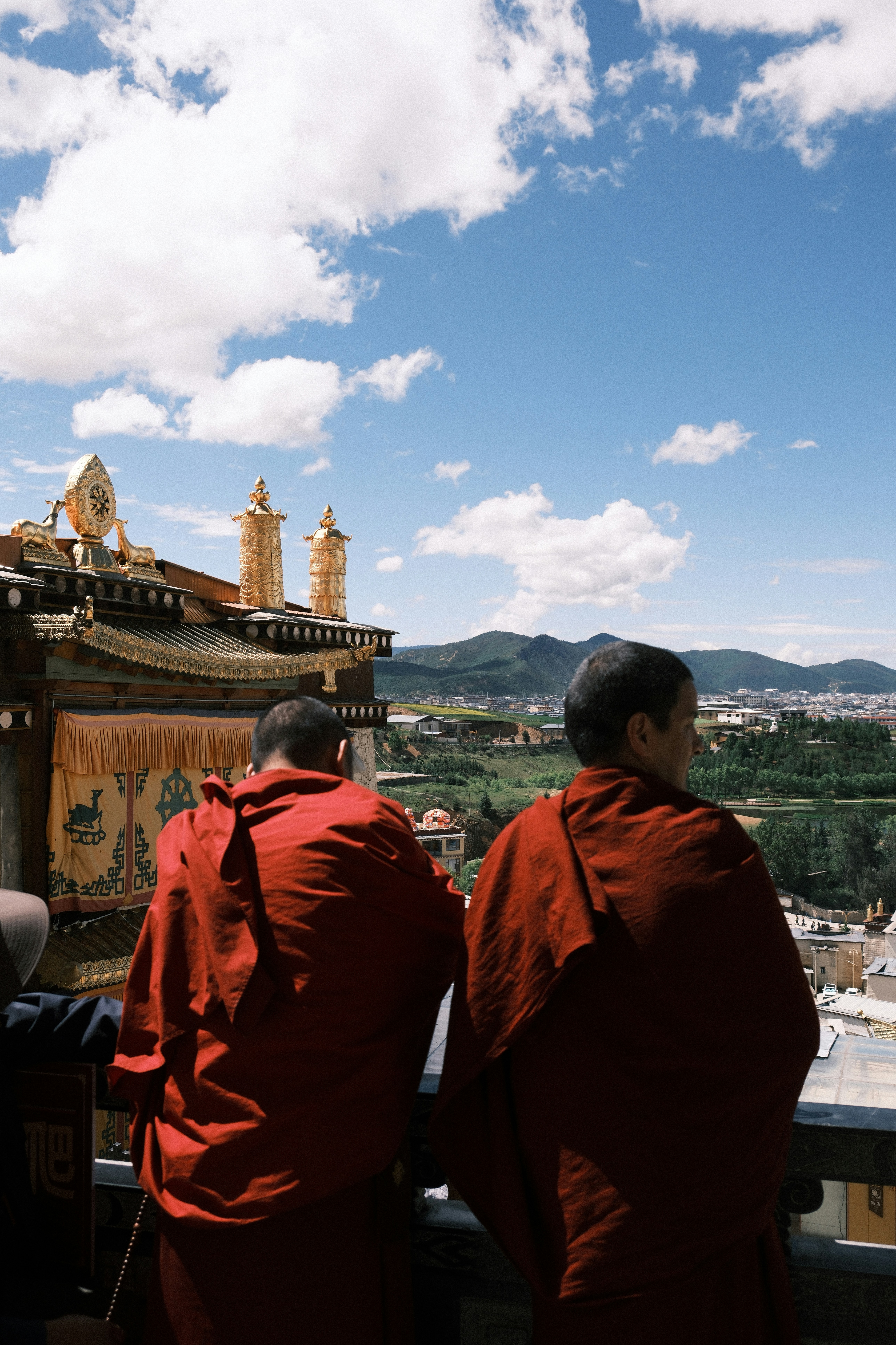 Red-robed Monks Overlooking a Temple Ridge