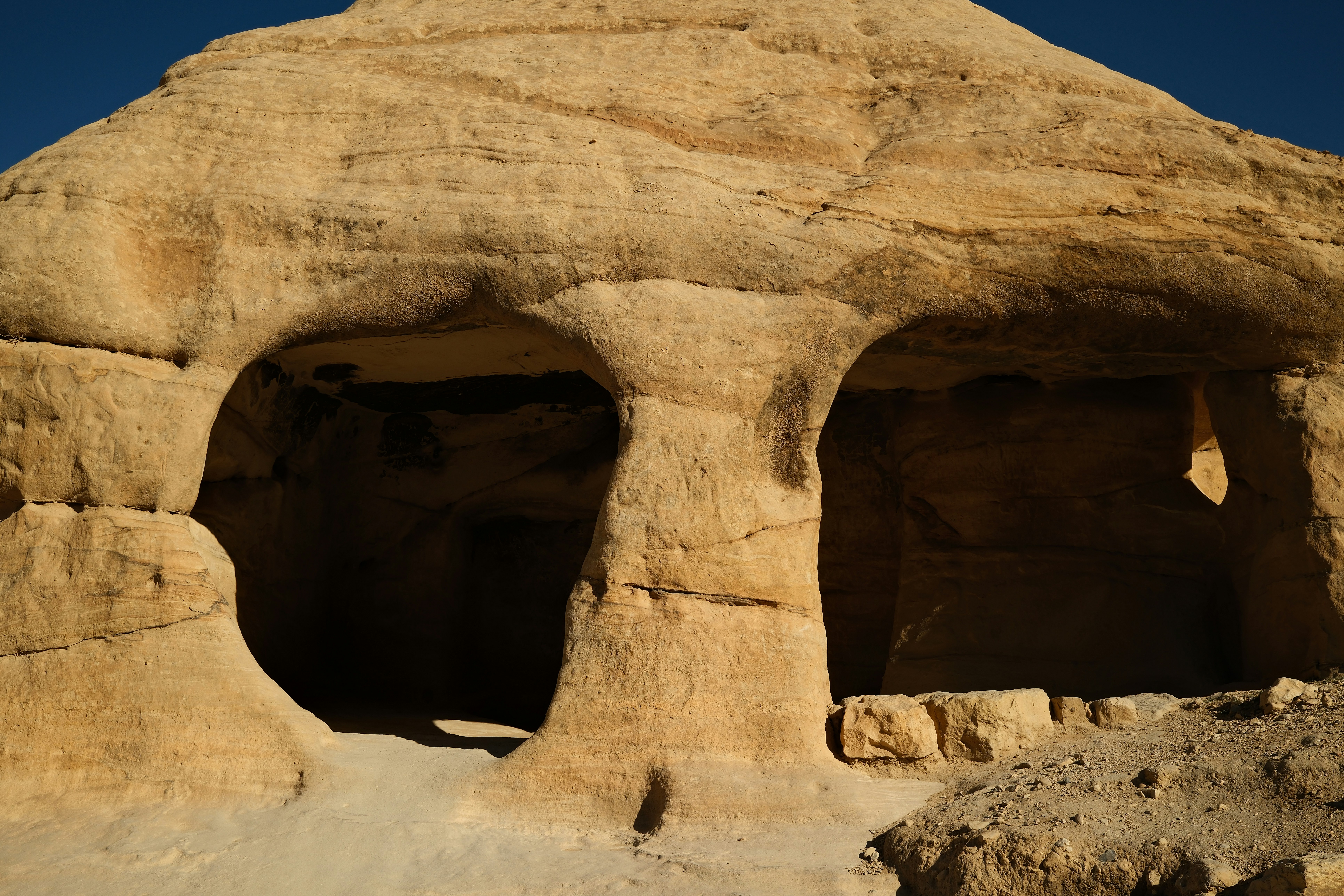 Sunlit Arch and Tunnel Carved in Desert Cliffs