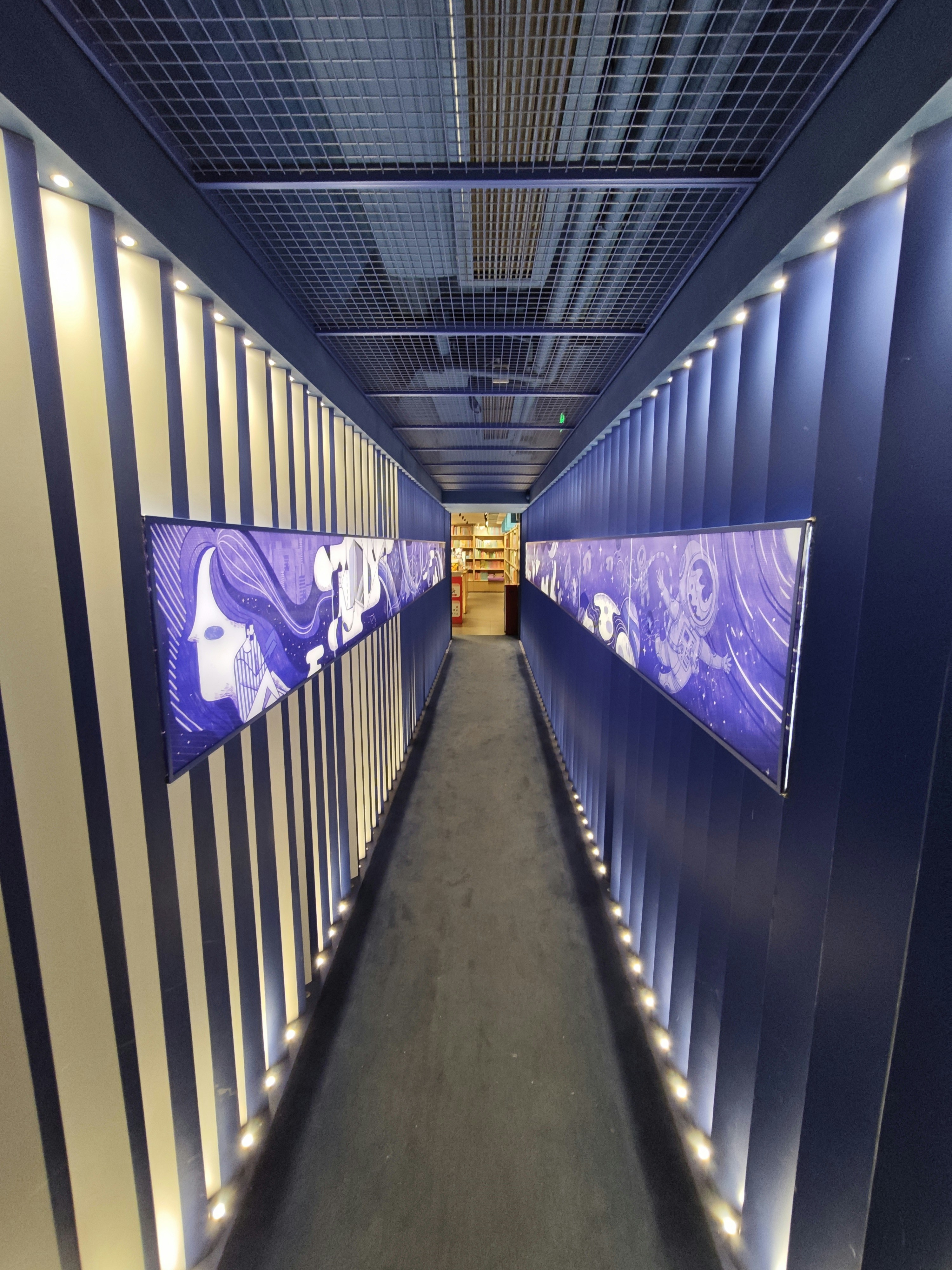Long Blue Corridor: Symmetry and Neon Panels in a Modern Passageway