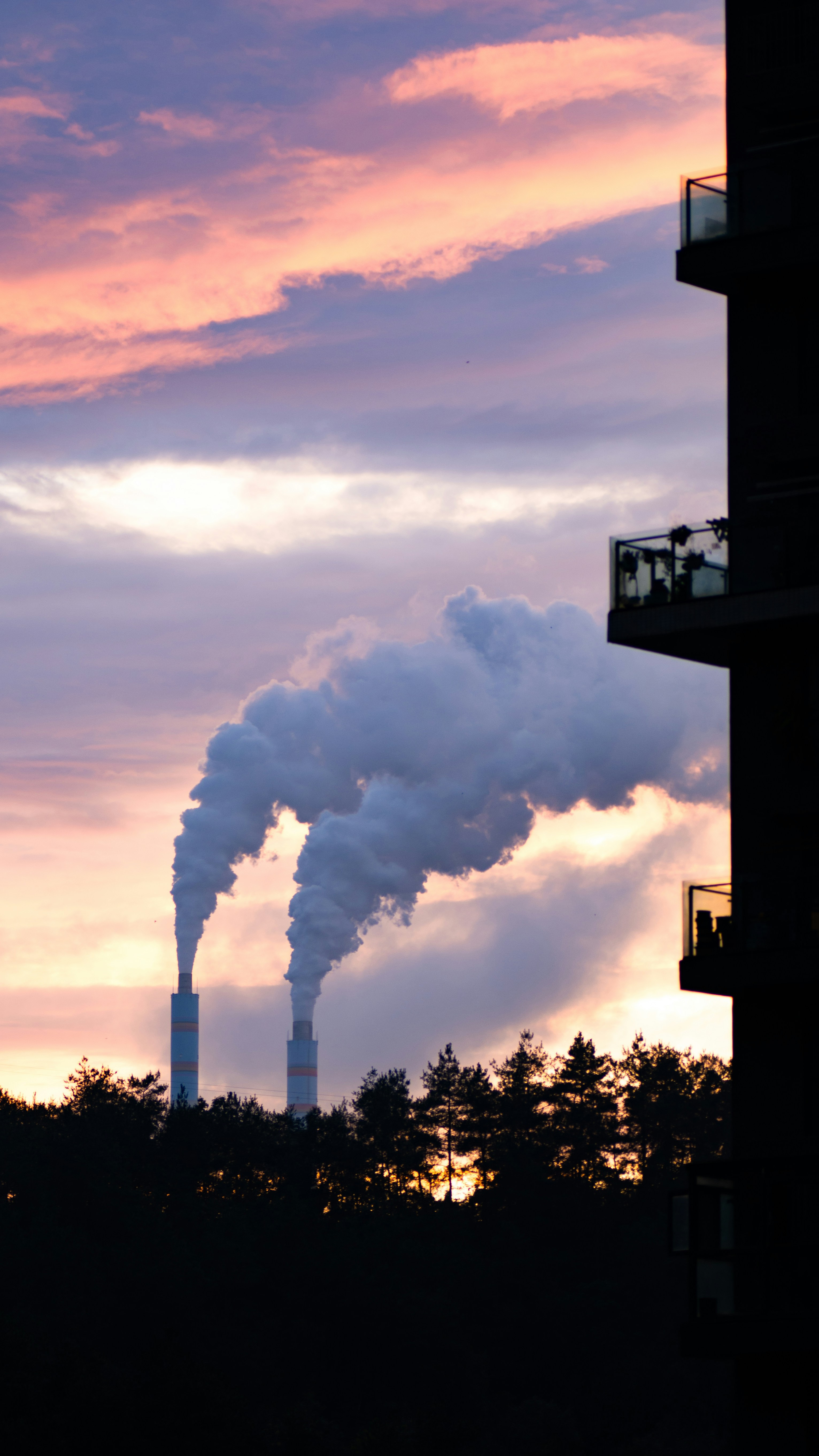 Sunset Skyline Over Smokestacks: A Quiet Industrial Poise