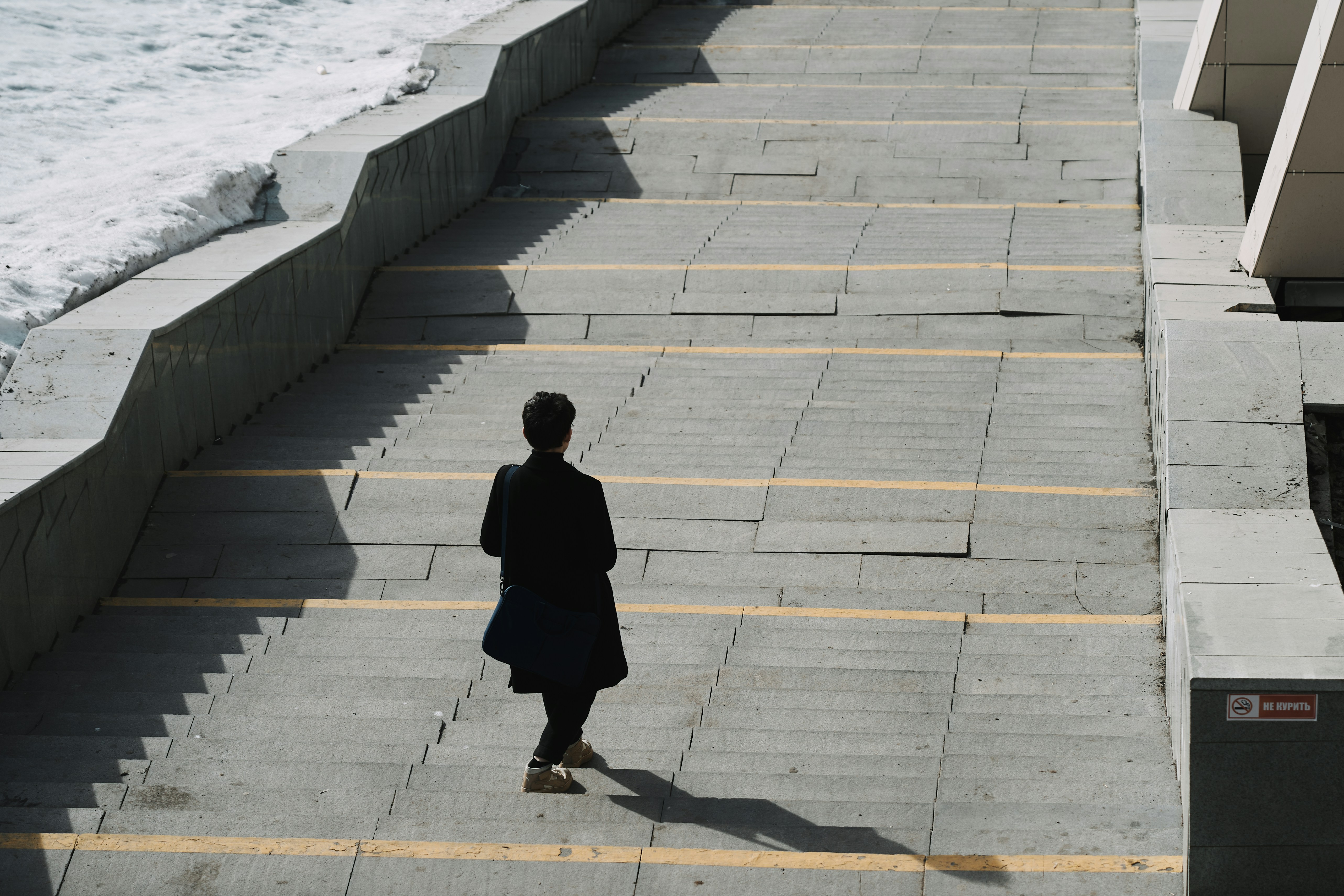 Solitary stride along a concrete promenade