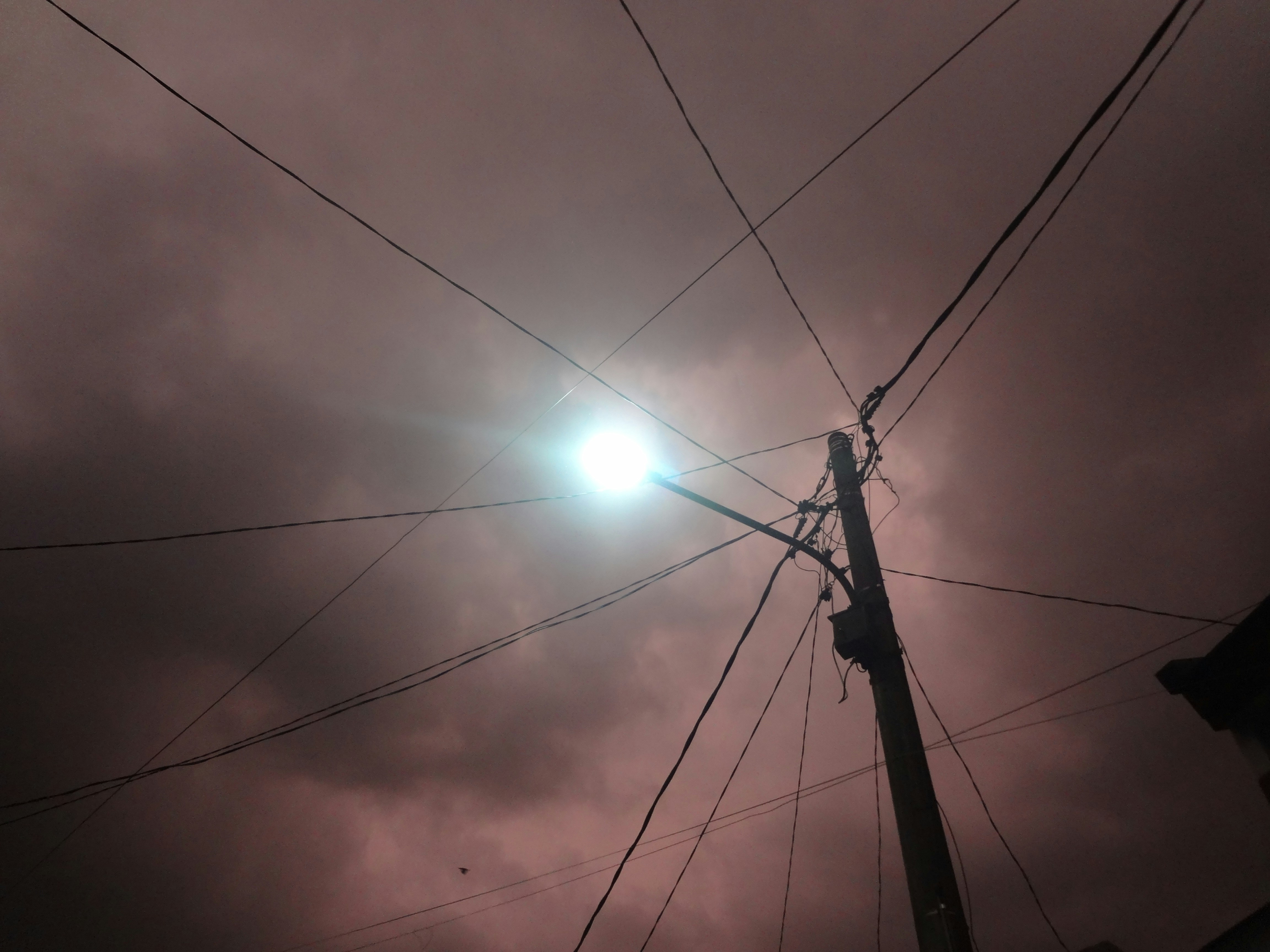 Luminous Street Crossroads under Night Cloudscape