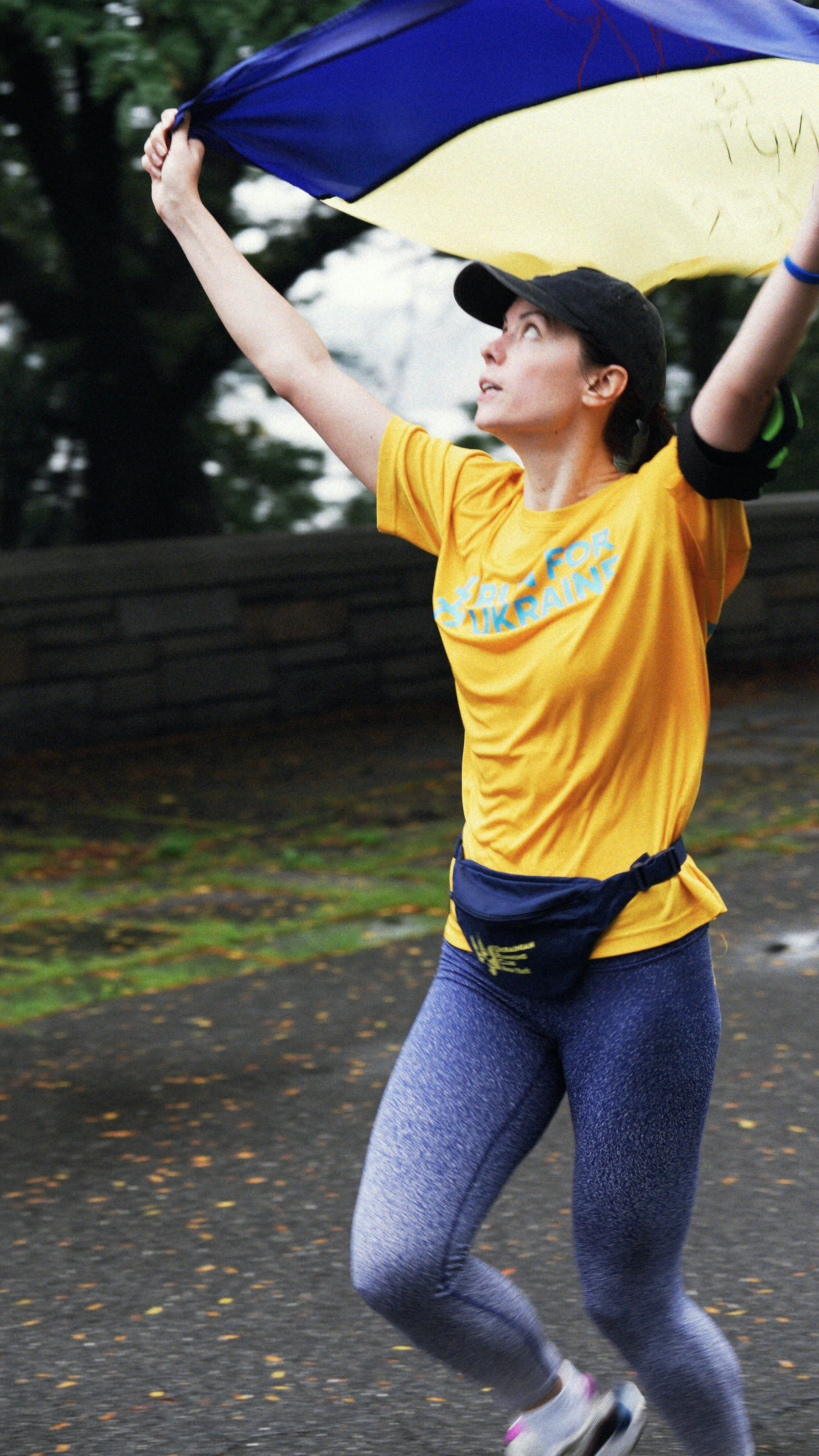 Raising the Banner: A Runner Waves a Yellow Shirt and Blue Flag