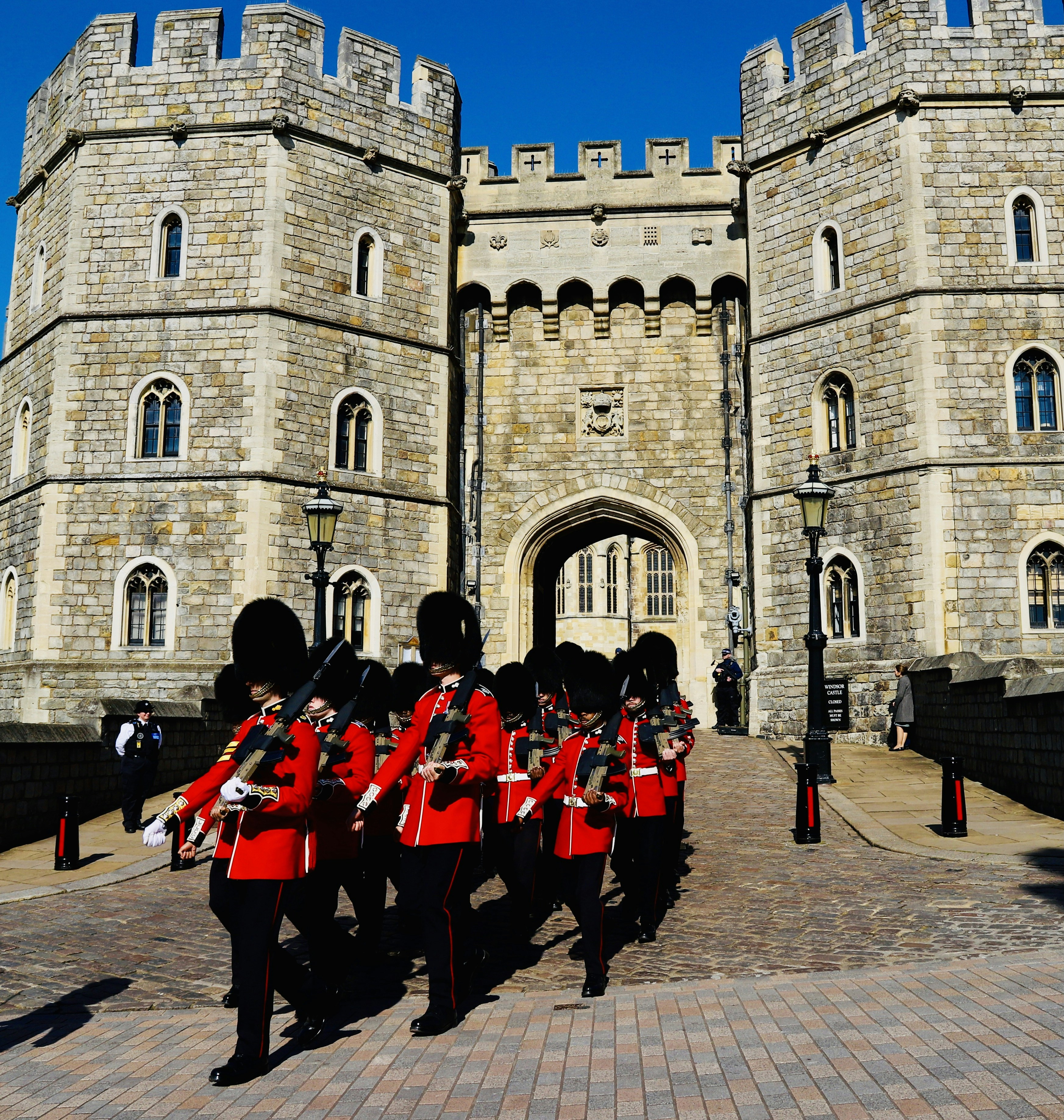 Ceremonial Guards Parade Before a Historic Gate