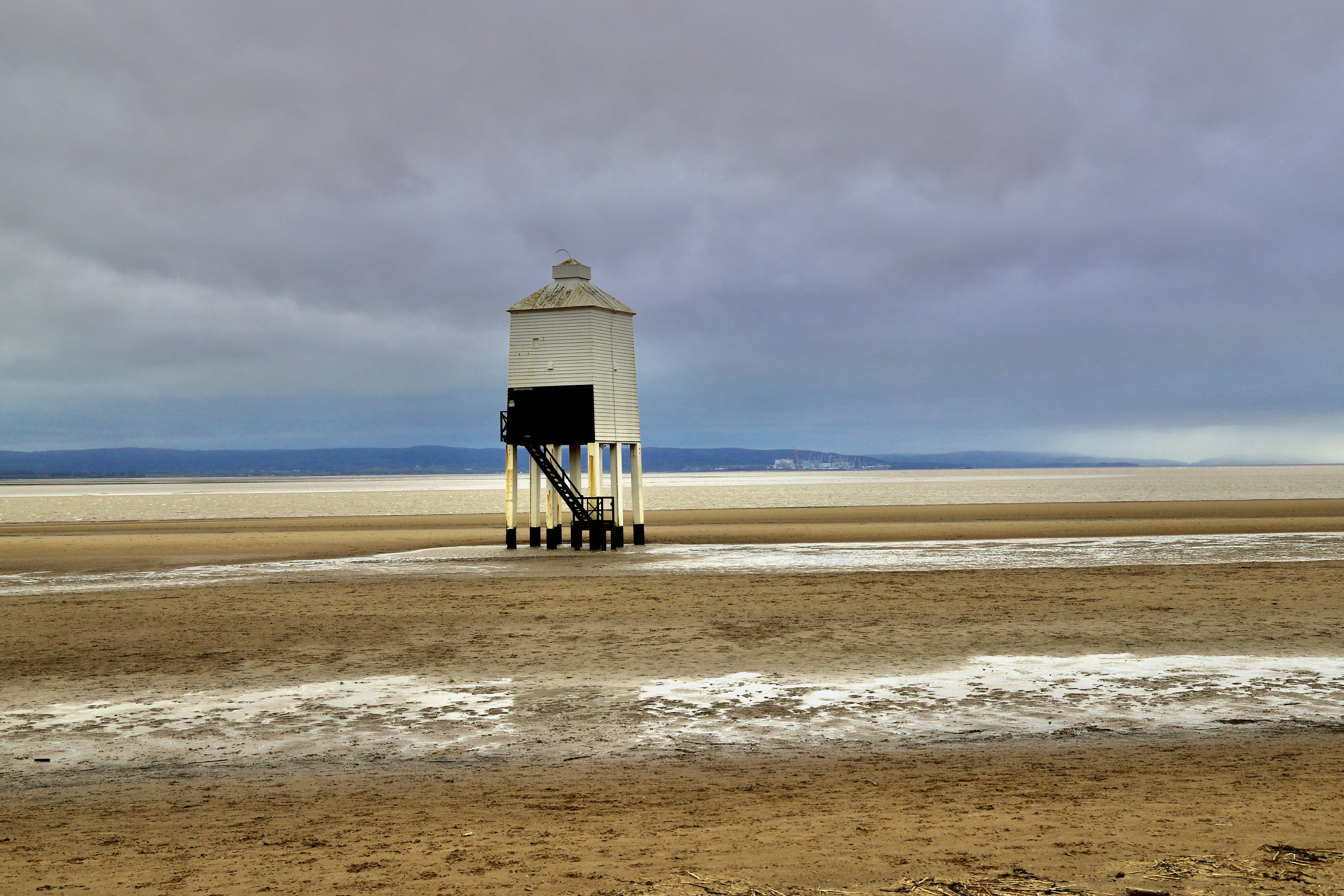 Stilted Beacon: A Lonely Lifeguard Tower Standing Against the Sea