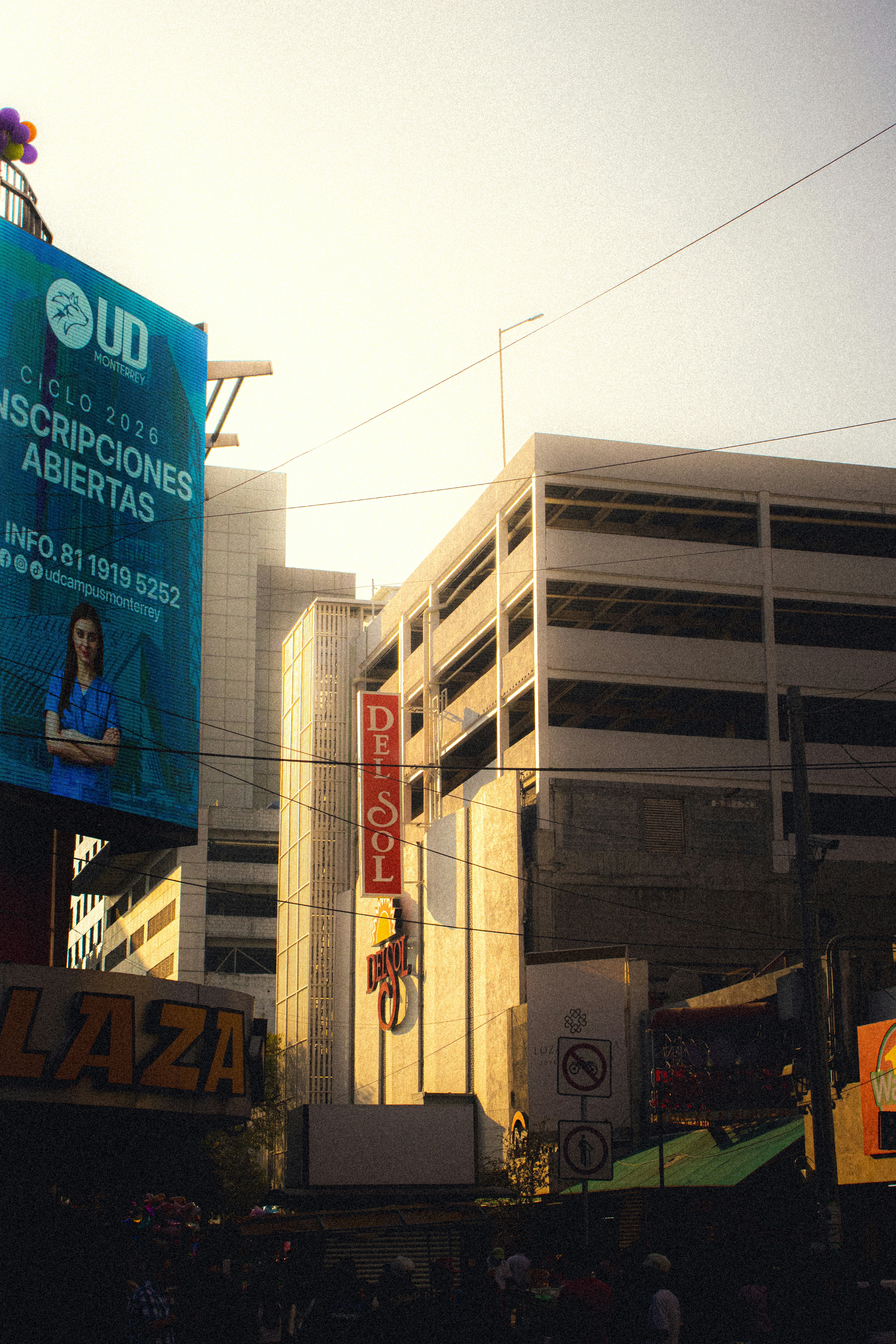 Neon Signs and City Lights on a Sunlit Avenida