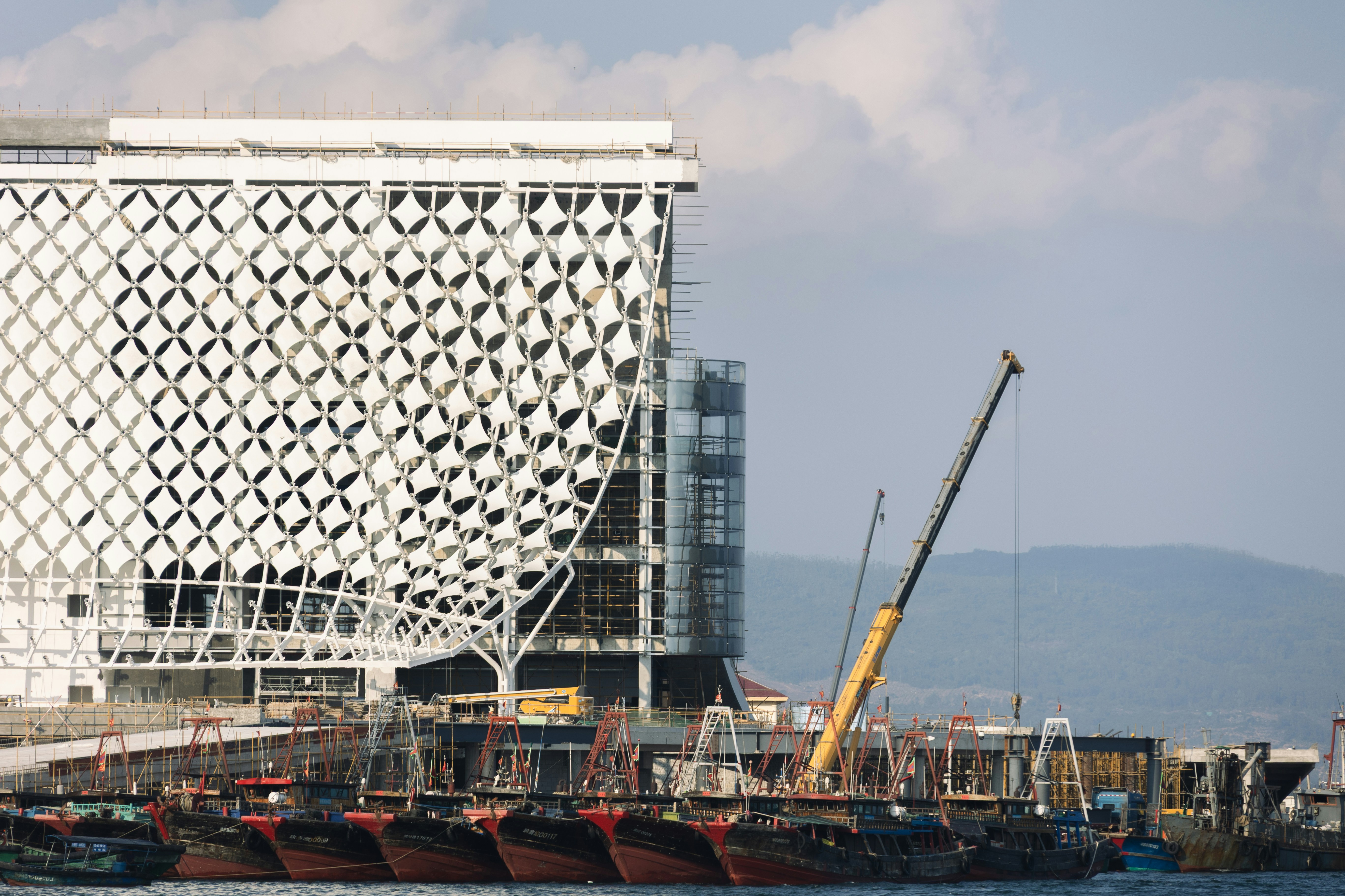 Crane Over a Waterfront Construction Parade by a Geometric Glass Soffit