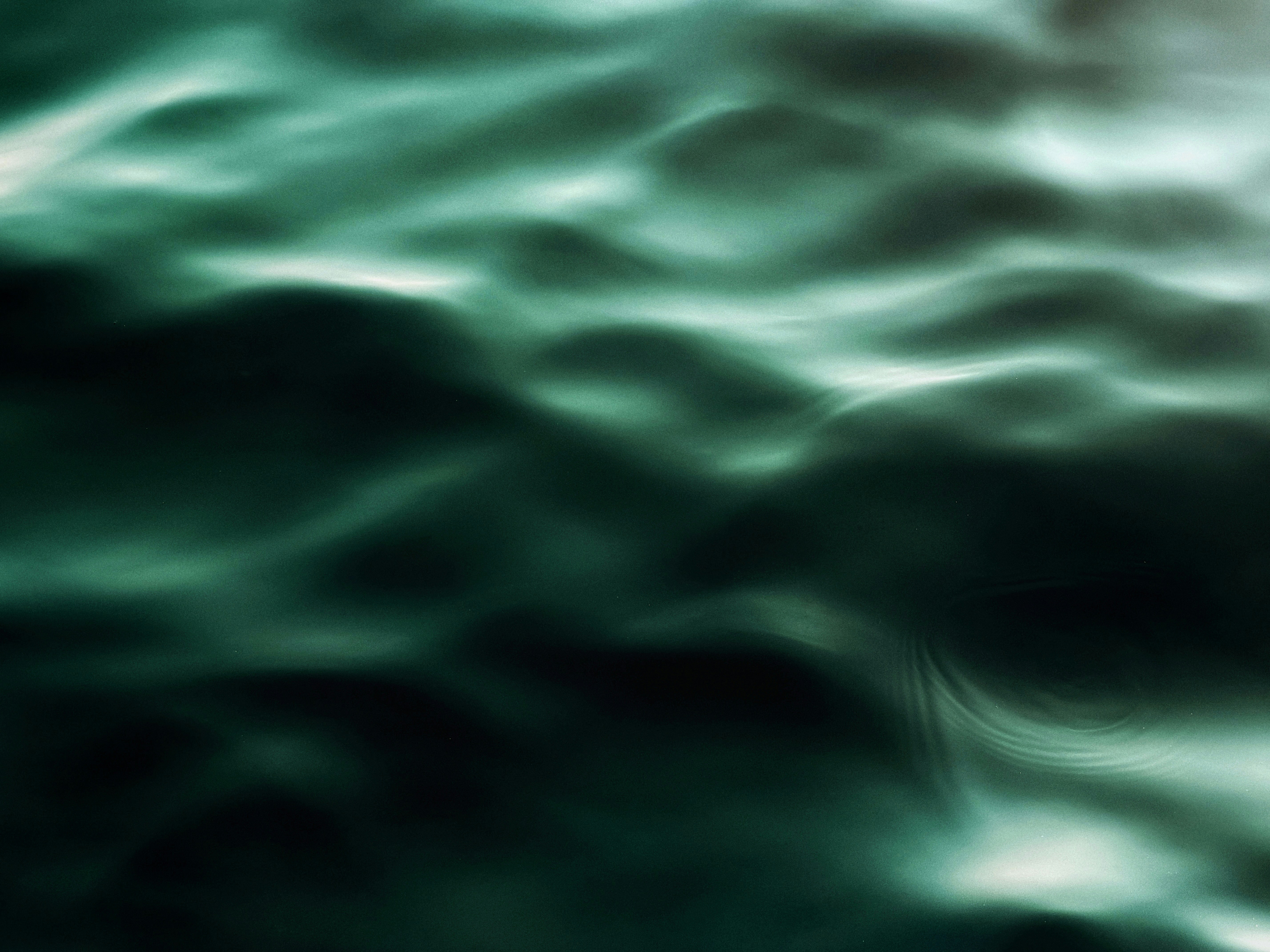 Tidal Veil: Soft Ridges of Green Light on Quiet Water