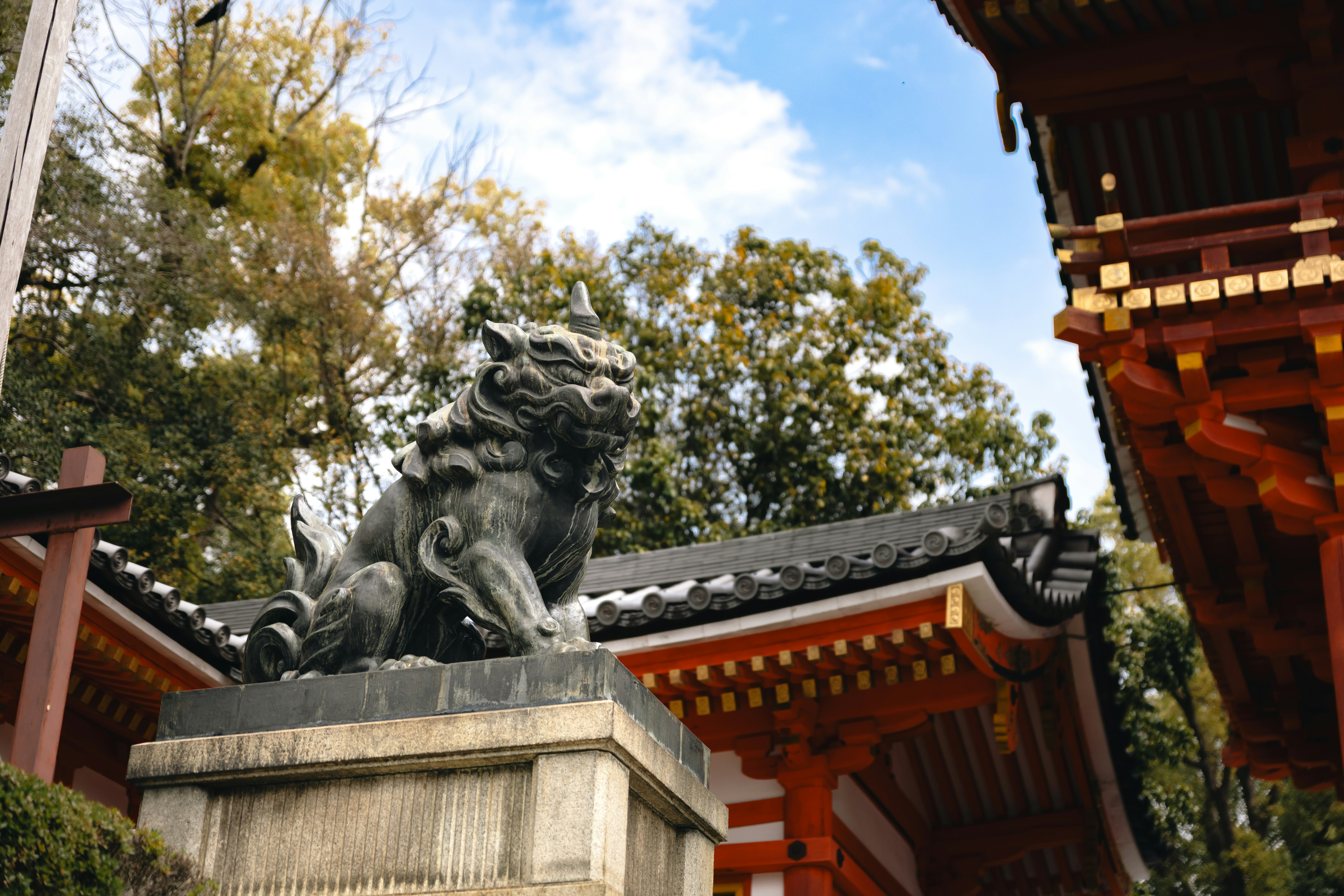 Stone lion statue guards traditional japanese temple entrance