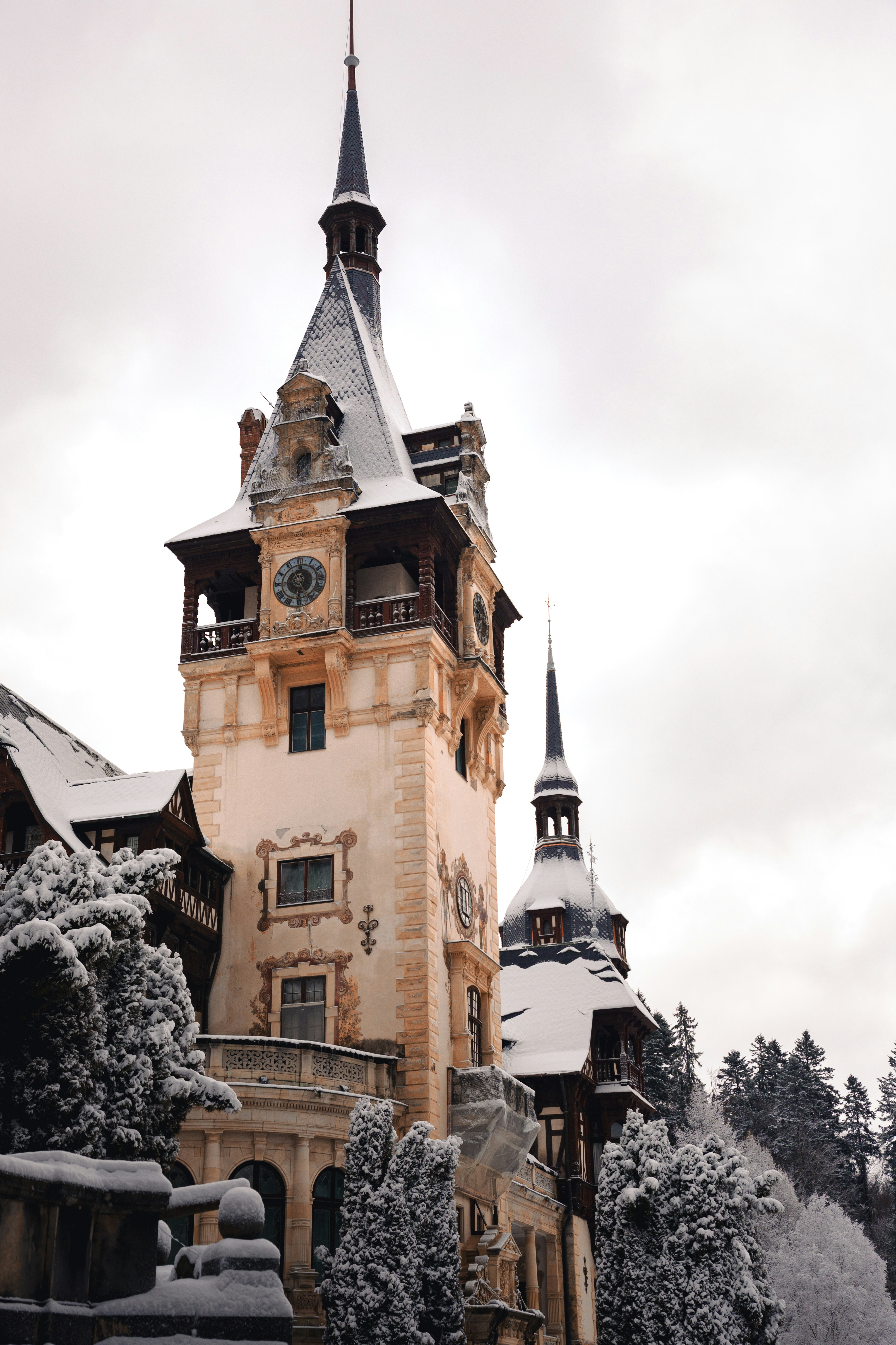 Snow-Kissed Chateau Spire Reaching Toward the Clouded Sky