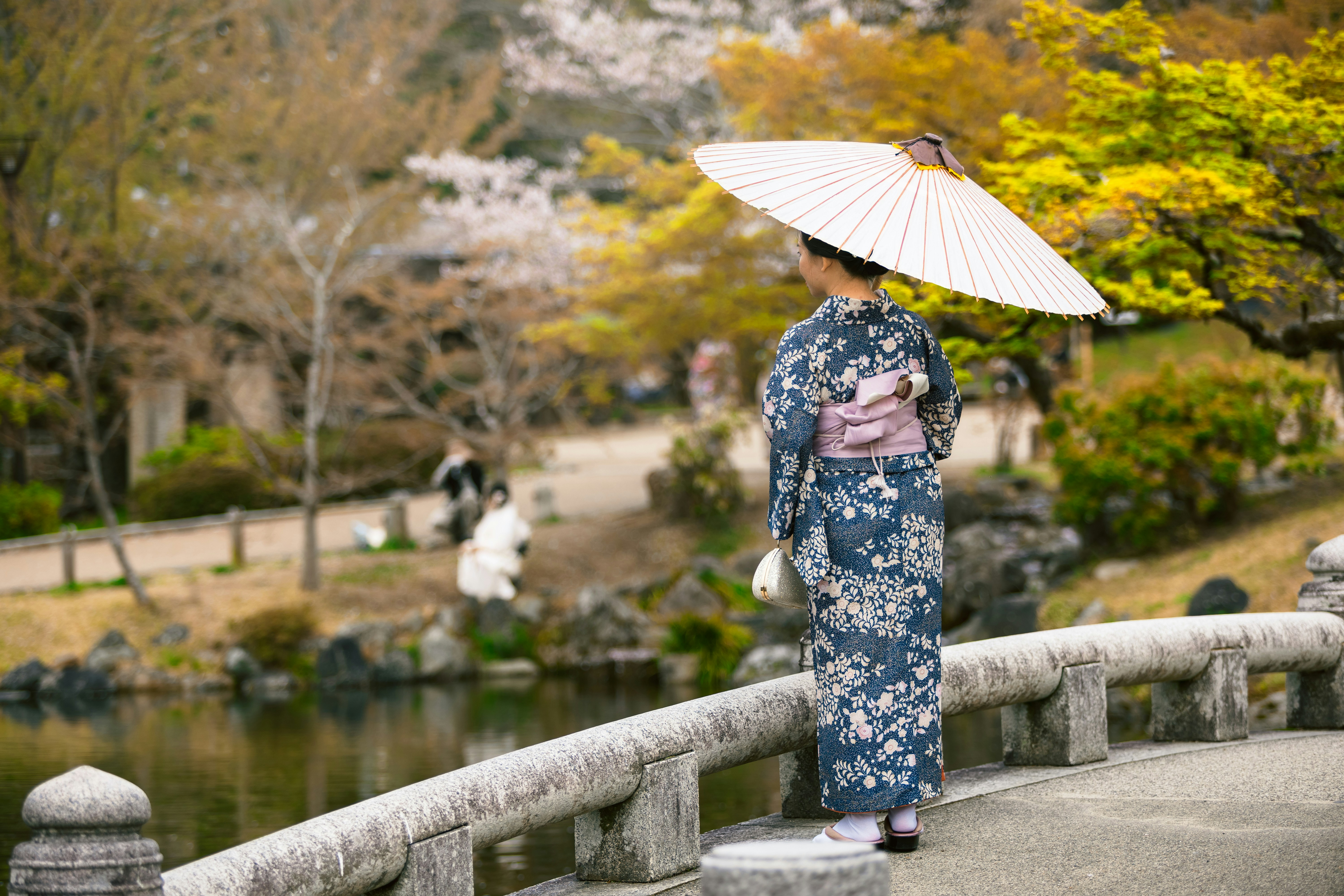 Kimono Reverie: A Seated Moment Under a Paper Parasol