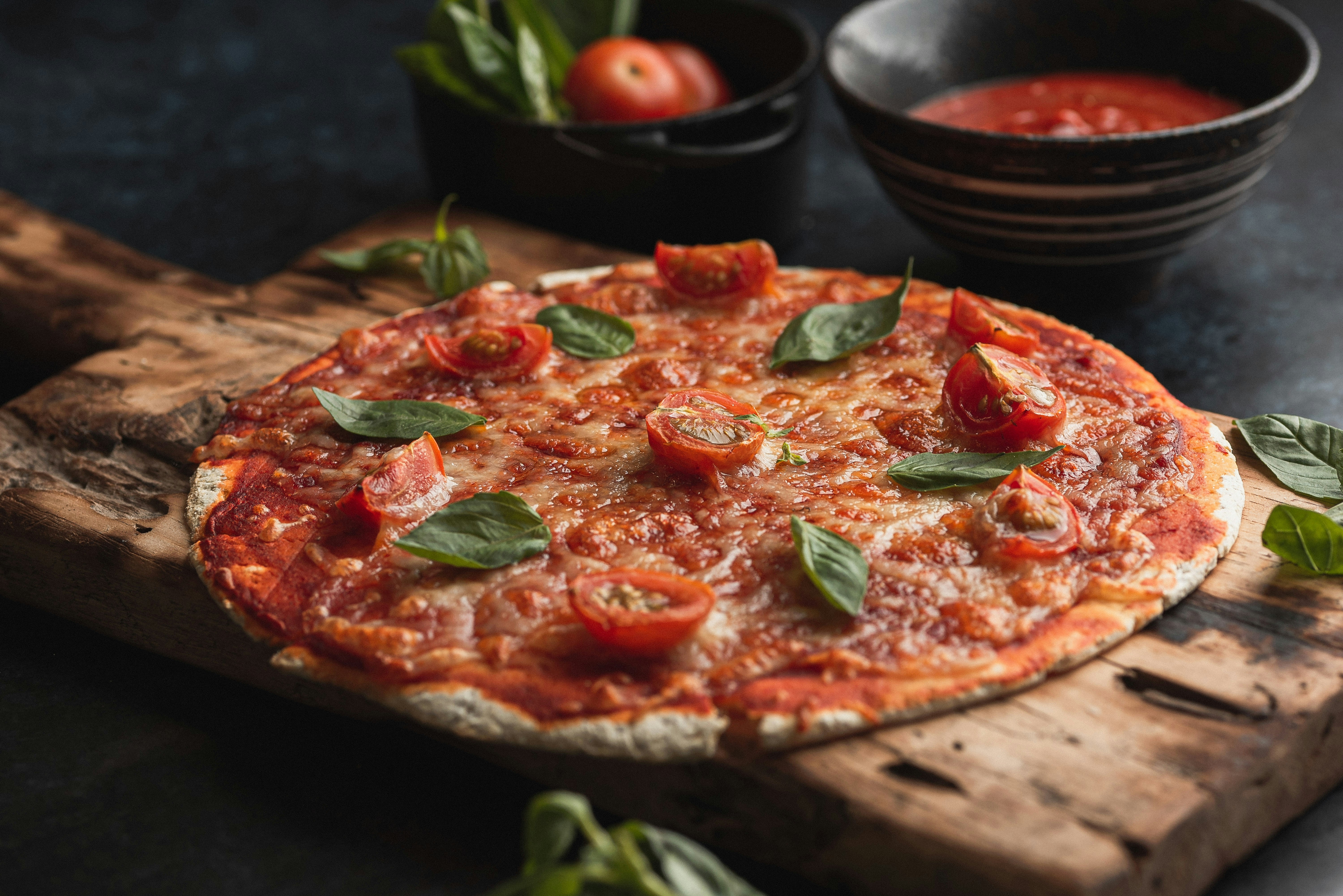 Heritage Pizza on a Rustic Board: Fresh Tomato Slice Symphony
