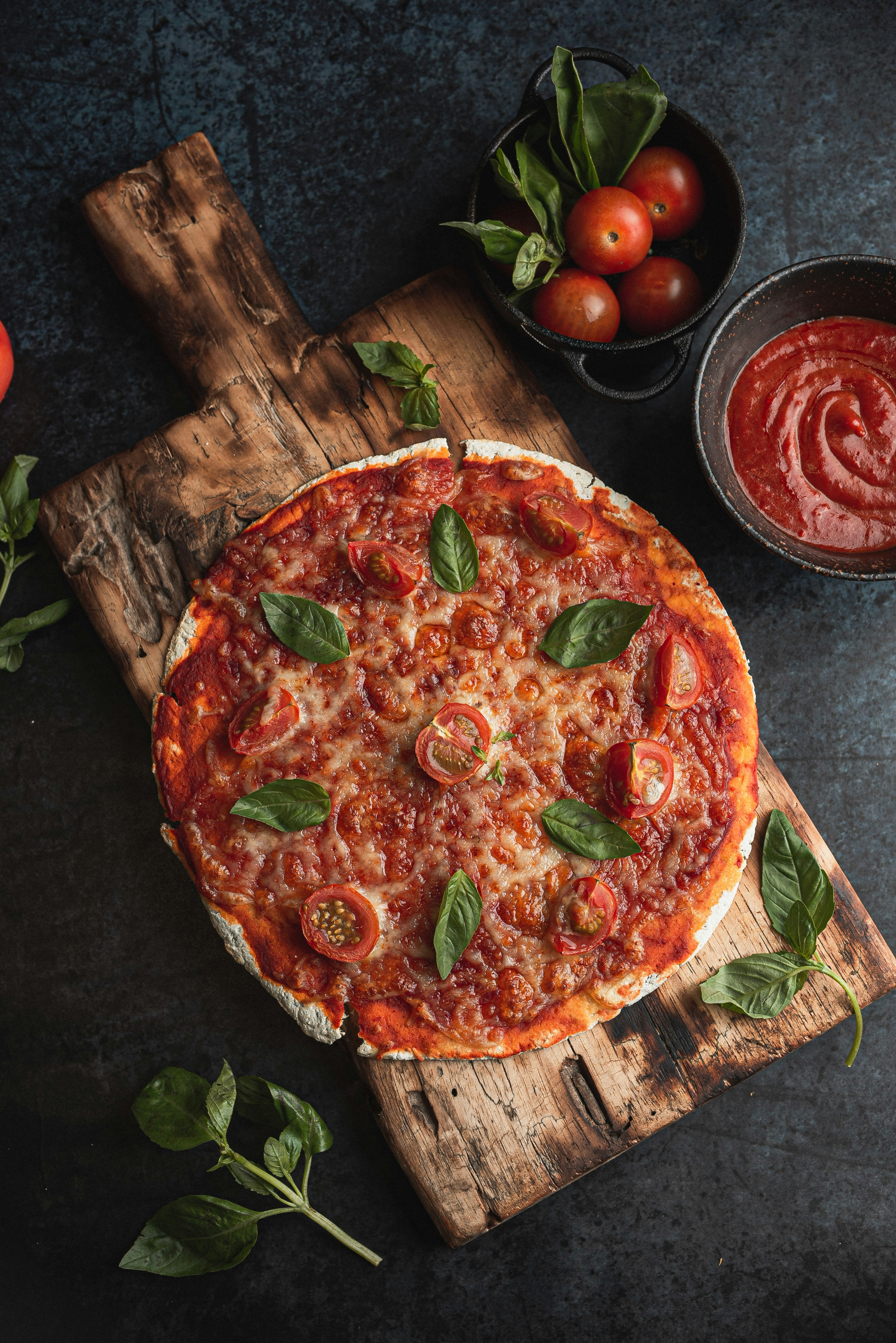 Rustic Wood Board Pepperoni Pizza on Dark Slate with Fresh Basil