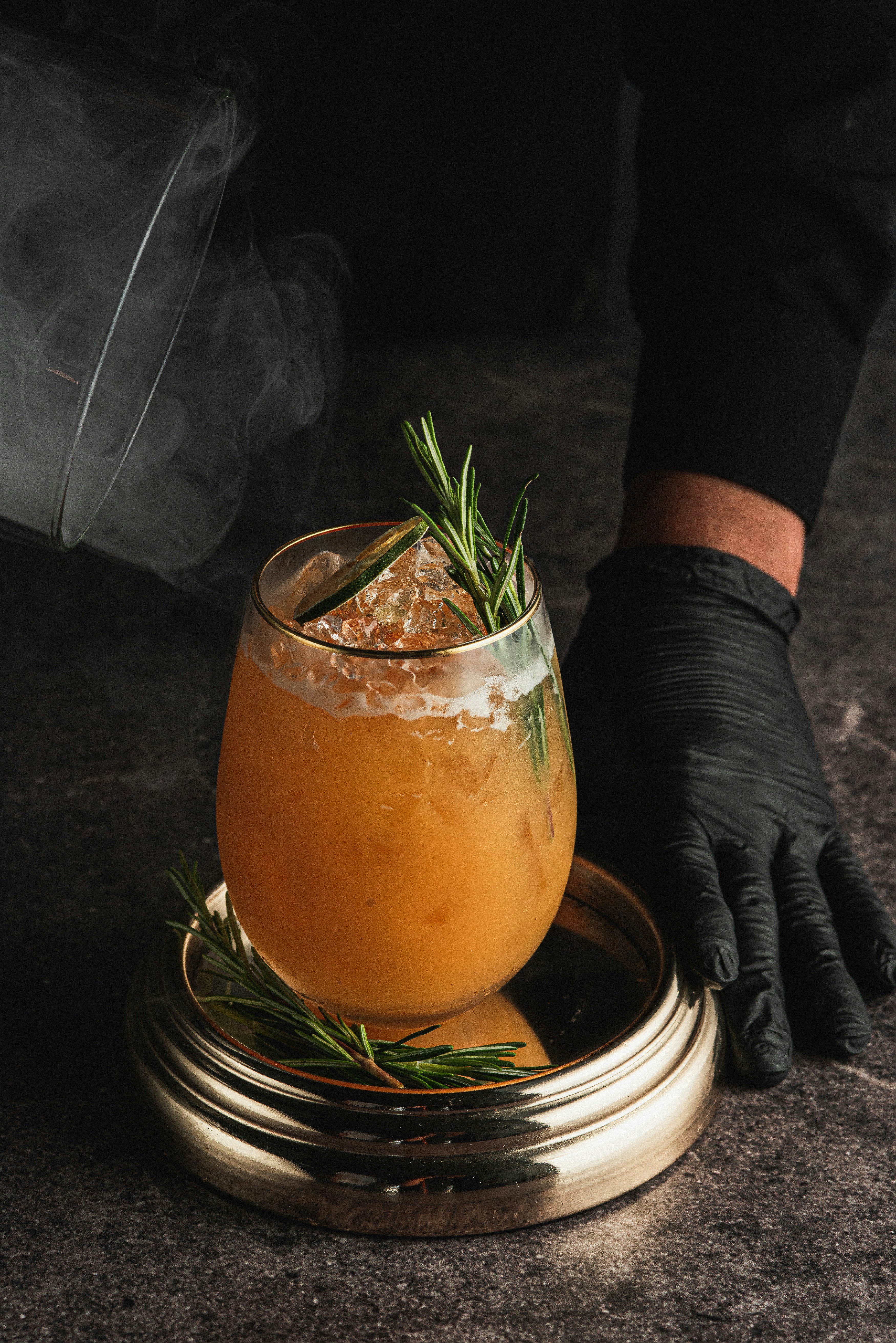 Herbal Ember: A Rosemary-Glazed Cocktail on a Copper Tray