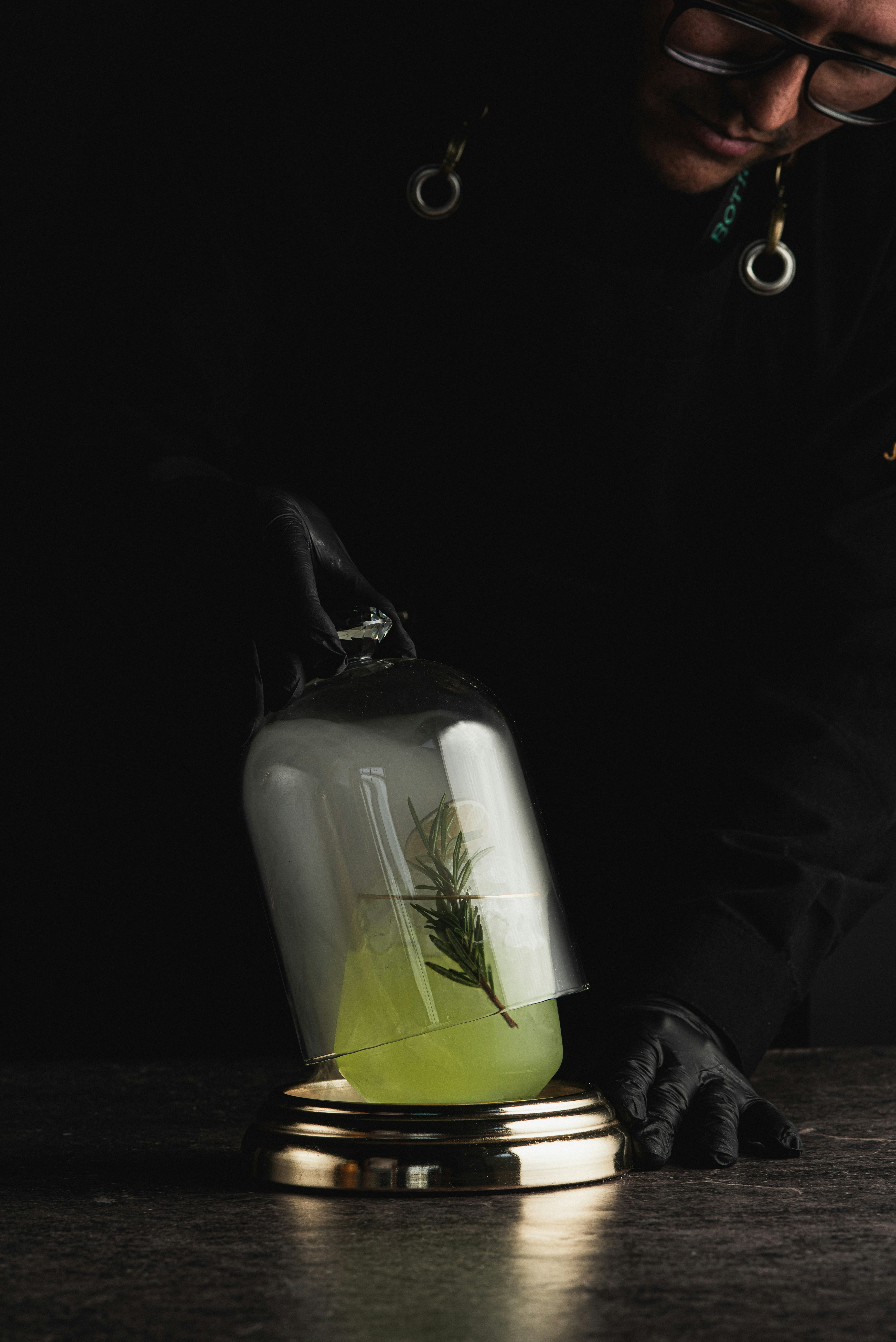 Herbal Alchemy under Glass: A Green Stem in a Dark Studio