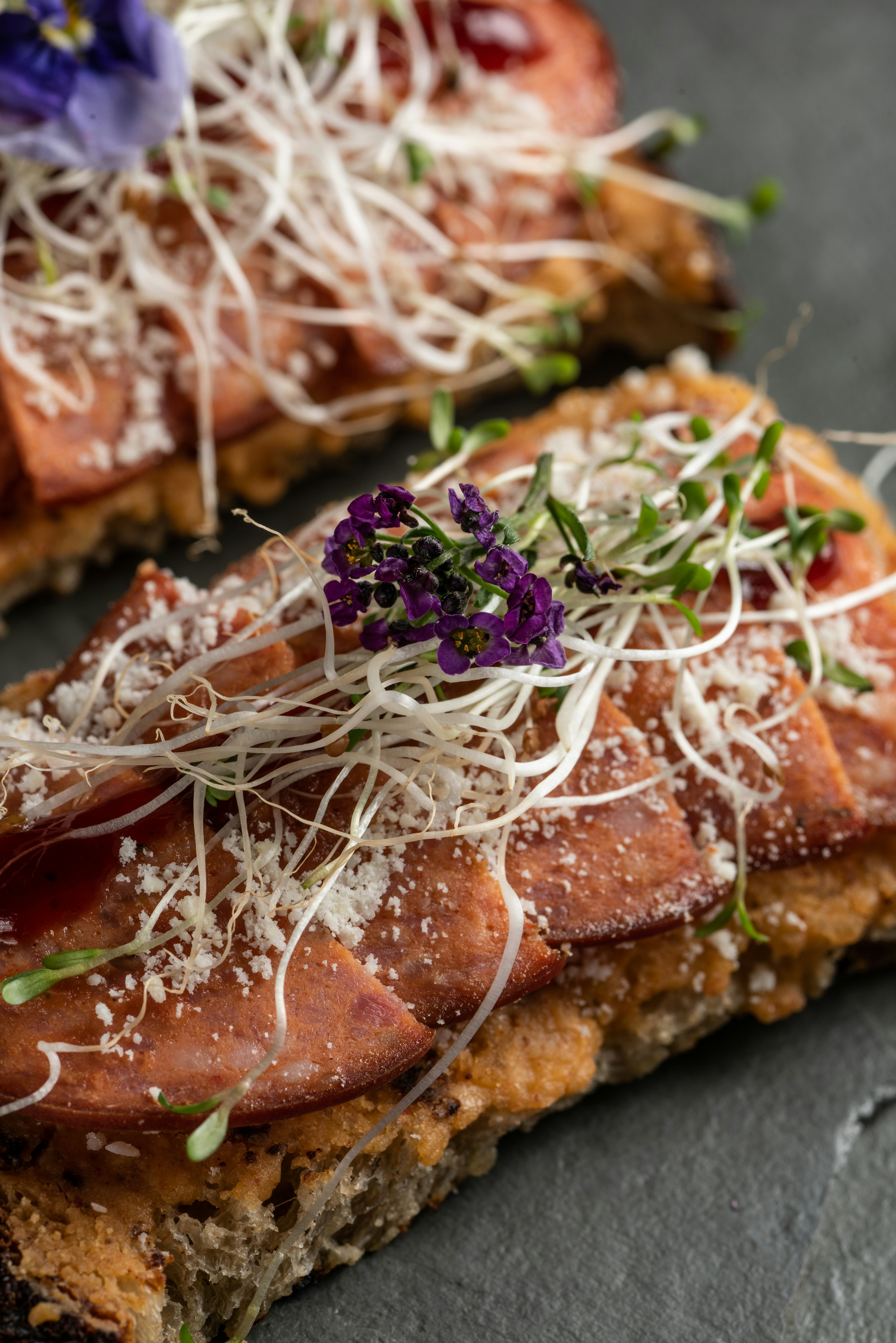 Crisped Toast with Microgreens and Purple Blossoms