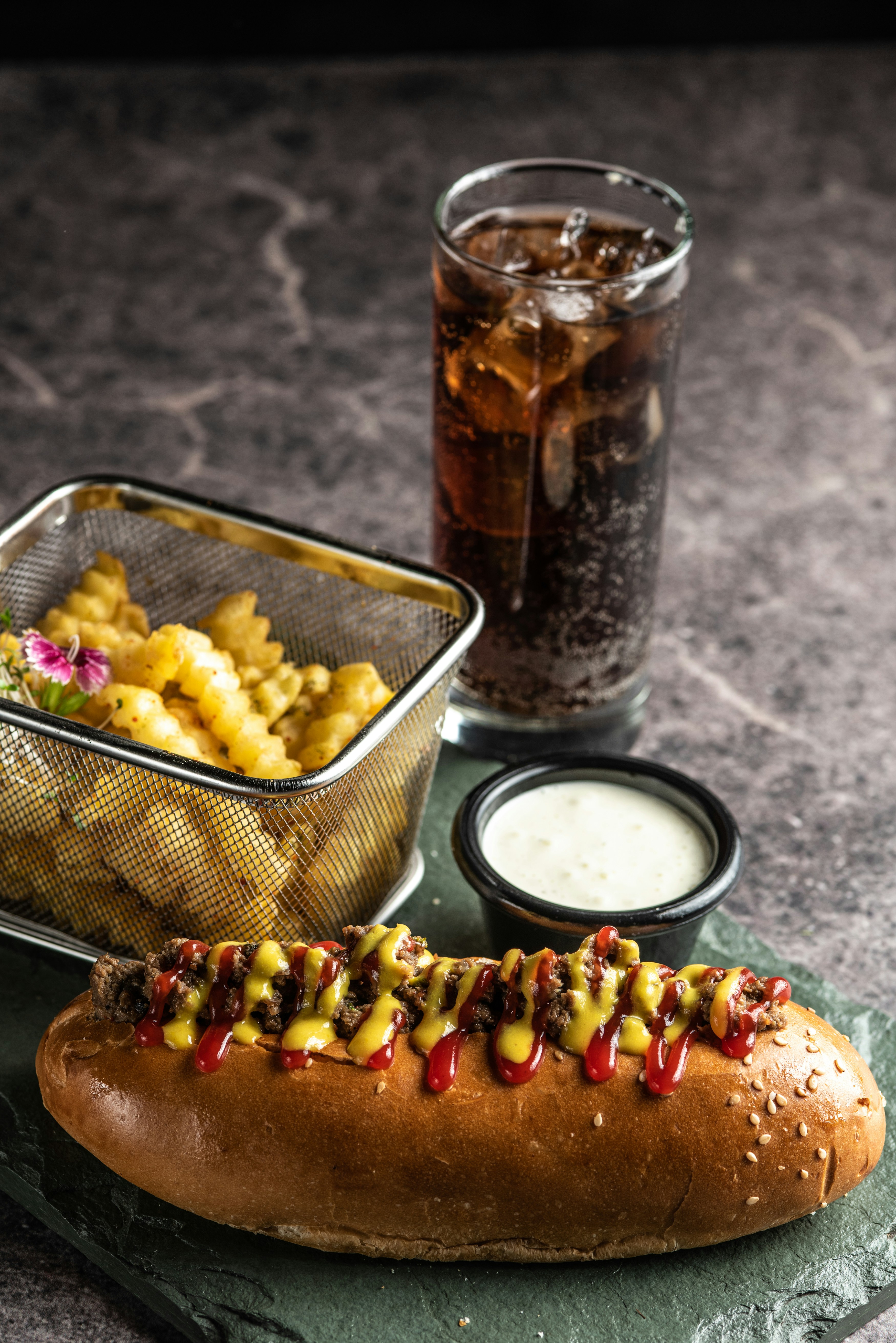 Loaded Coney Bite: A Snack Platter with Fries, Dip, and a Drizzle-Laden Hot Dog