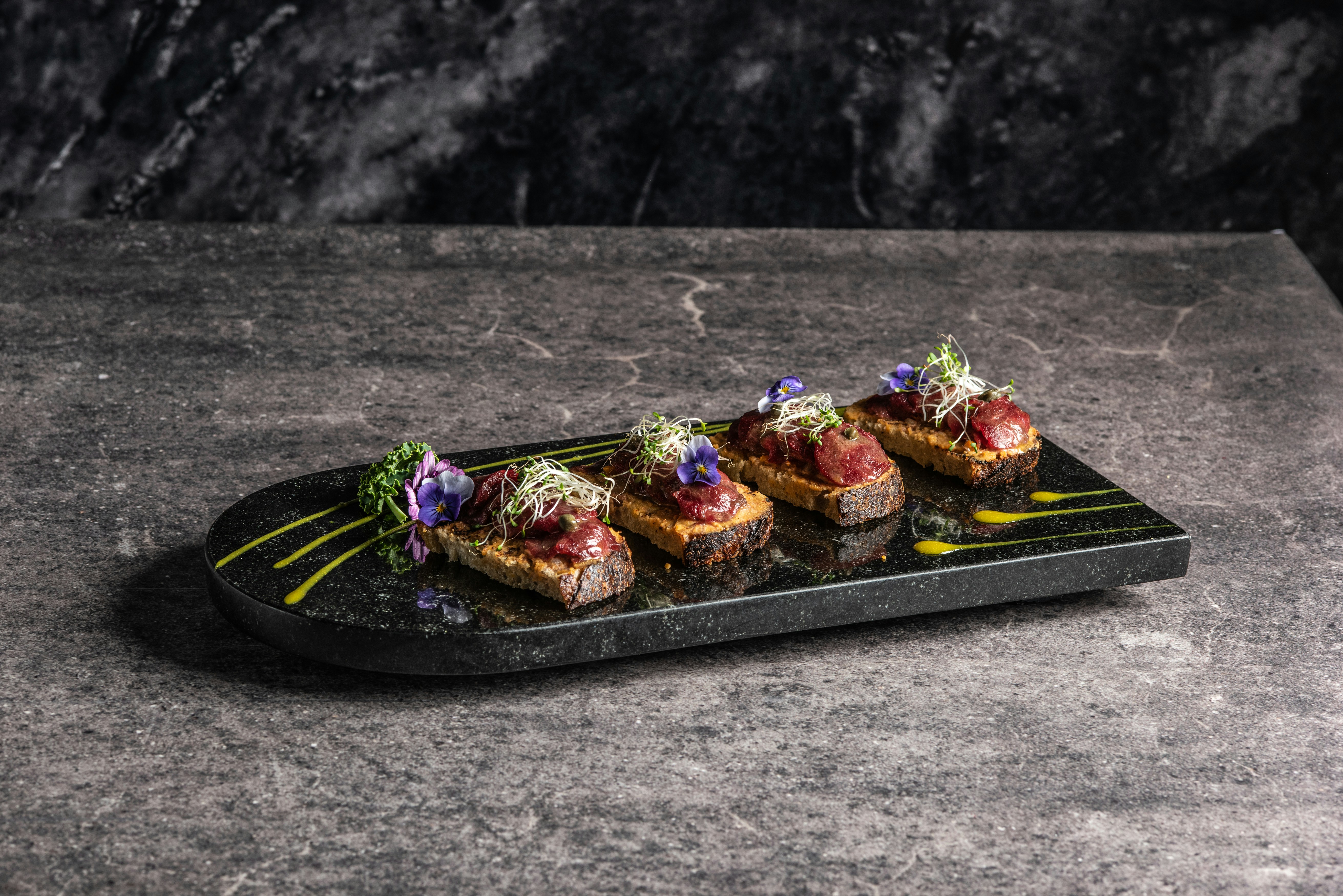Miniature Quartet: Gourmet Tarts on a Slate Canvas
