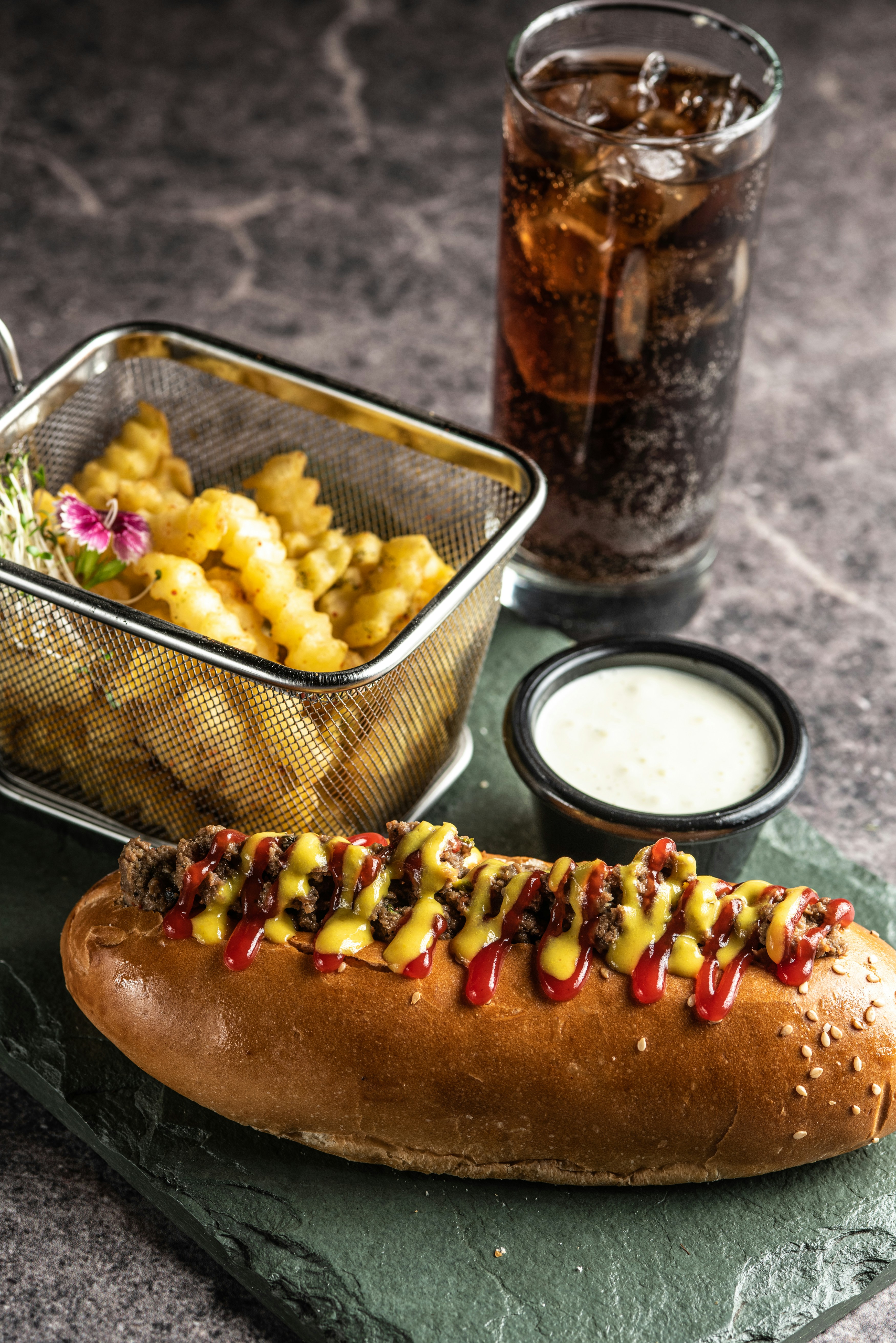 Golden Hot Dog Triumph: Fries, Dip, and Soda in a Rustic Platter