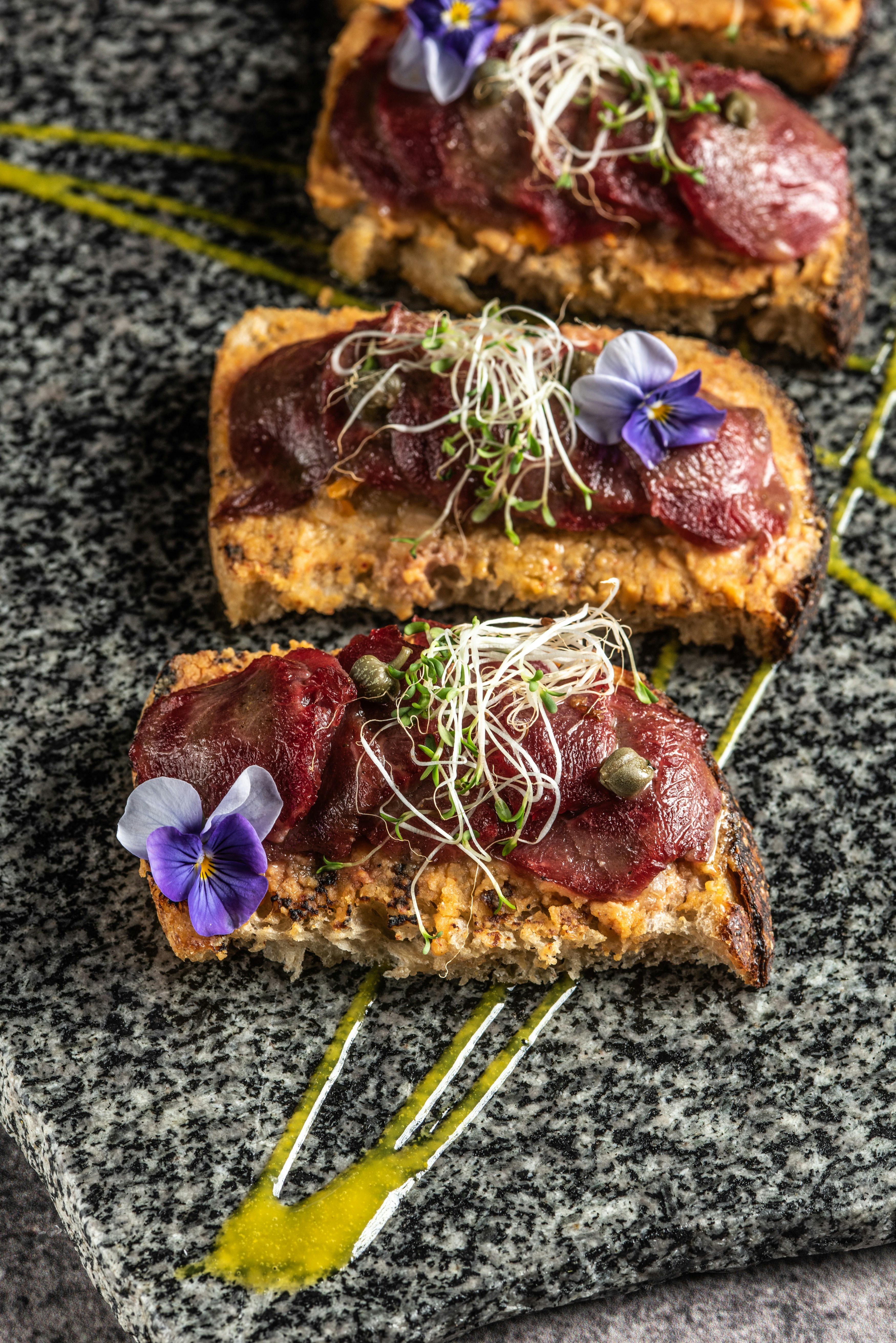 Three Seared Tuna Crostini with Microgreens and Edible Flowers