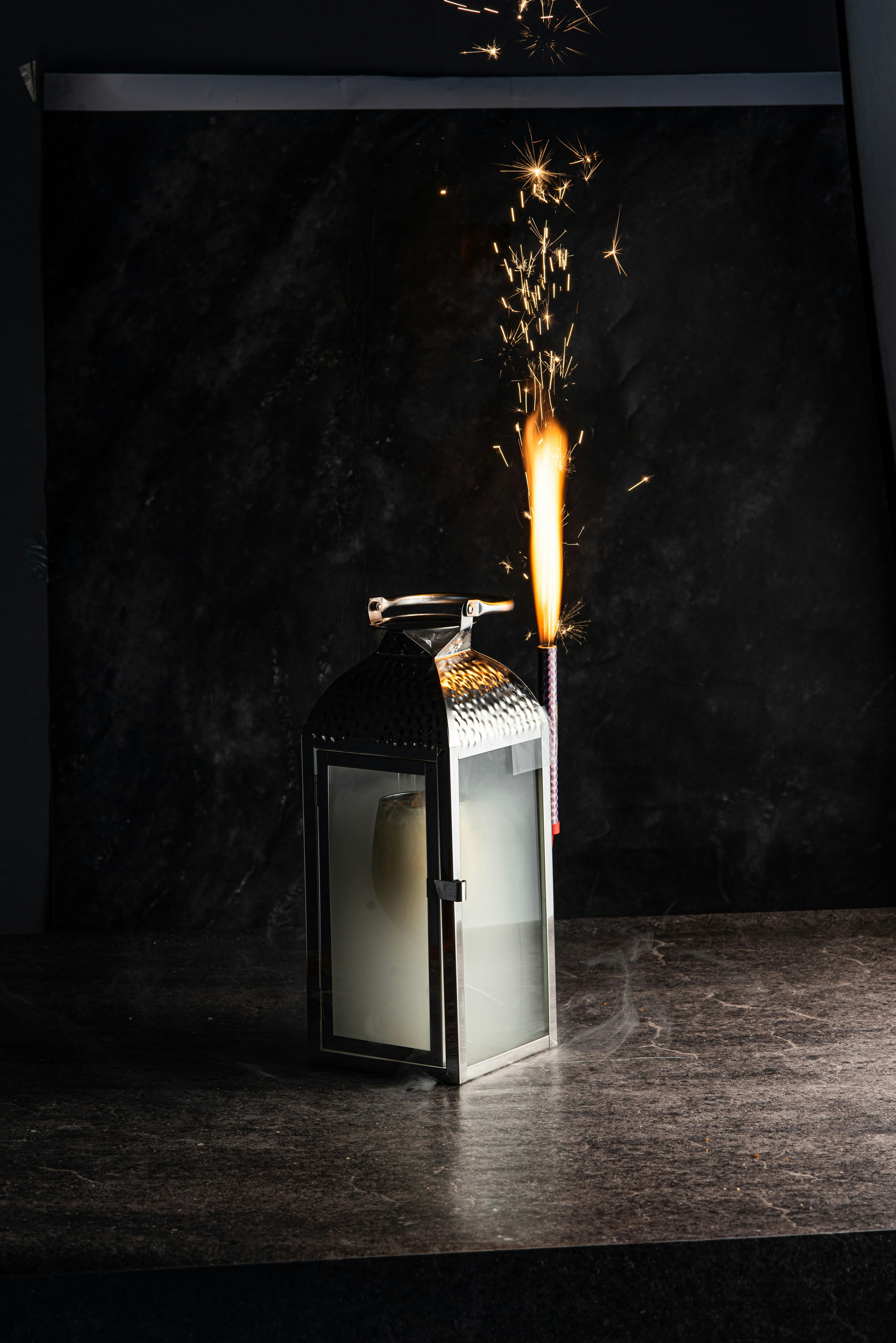 Lantern Spark: A Quiet Moment of Firework Within Steel Edges