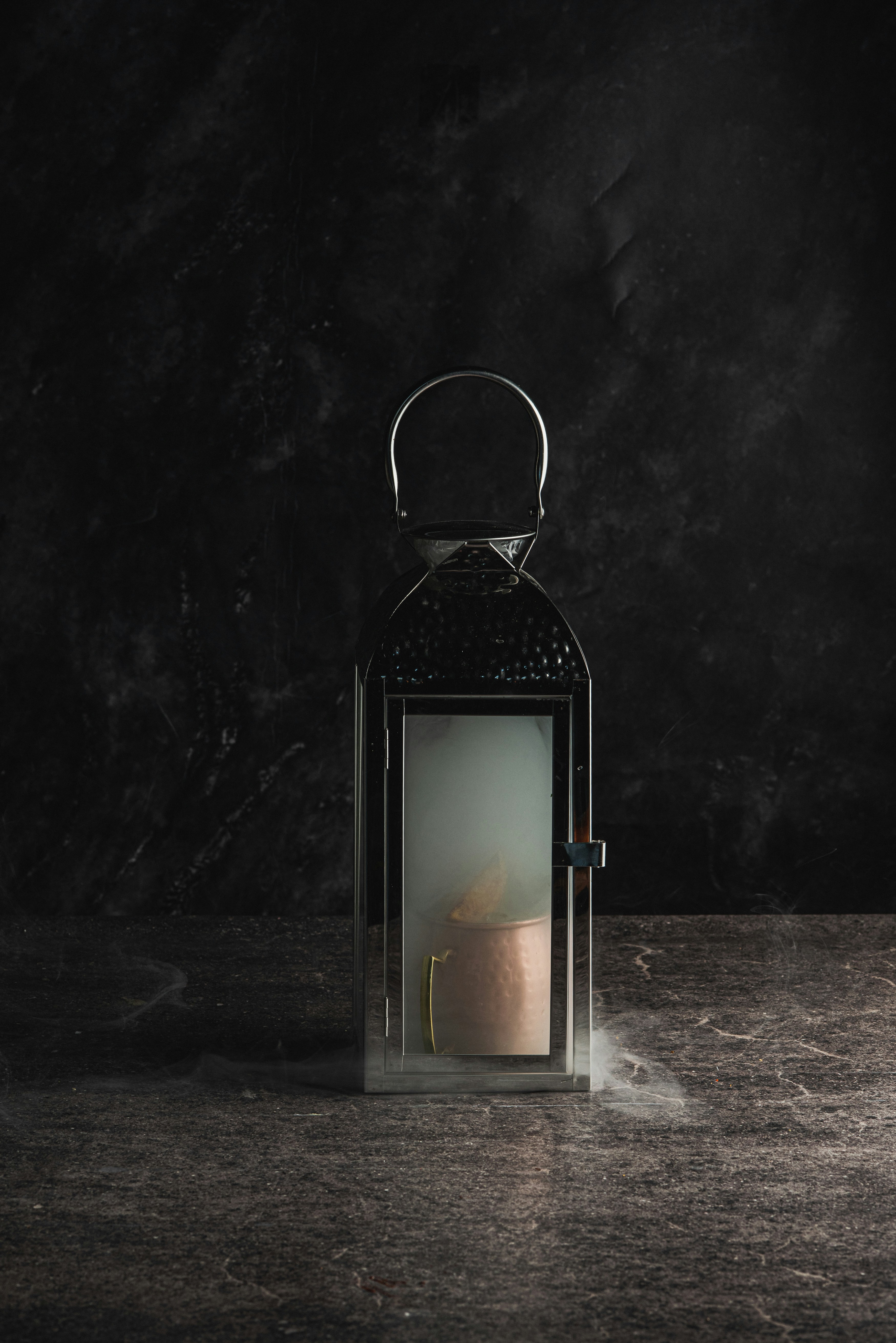 Midnight Lantern: A Lantern Sculpture Resting on a Weathered Surface