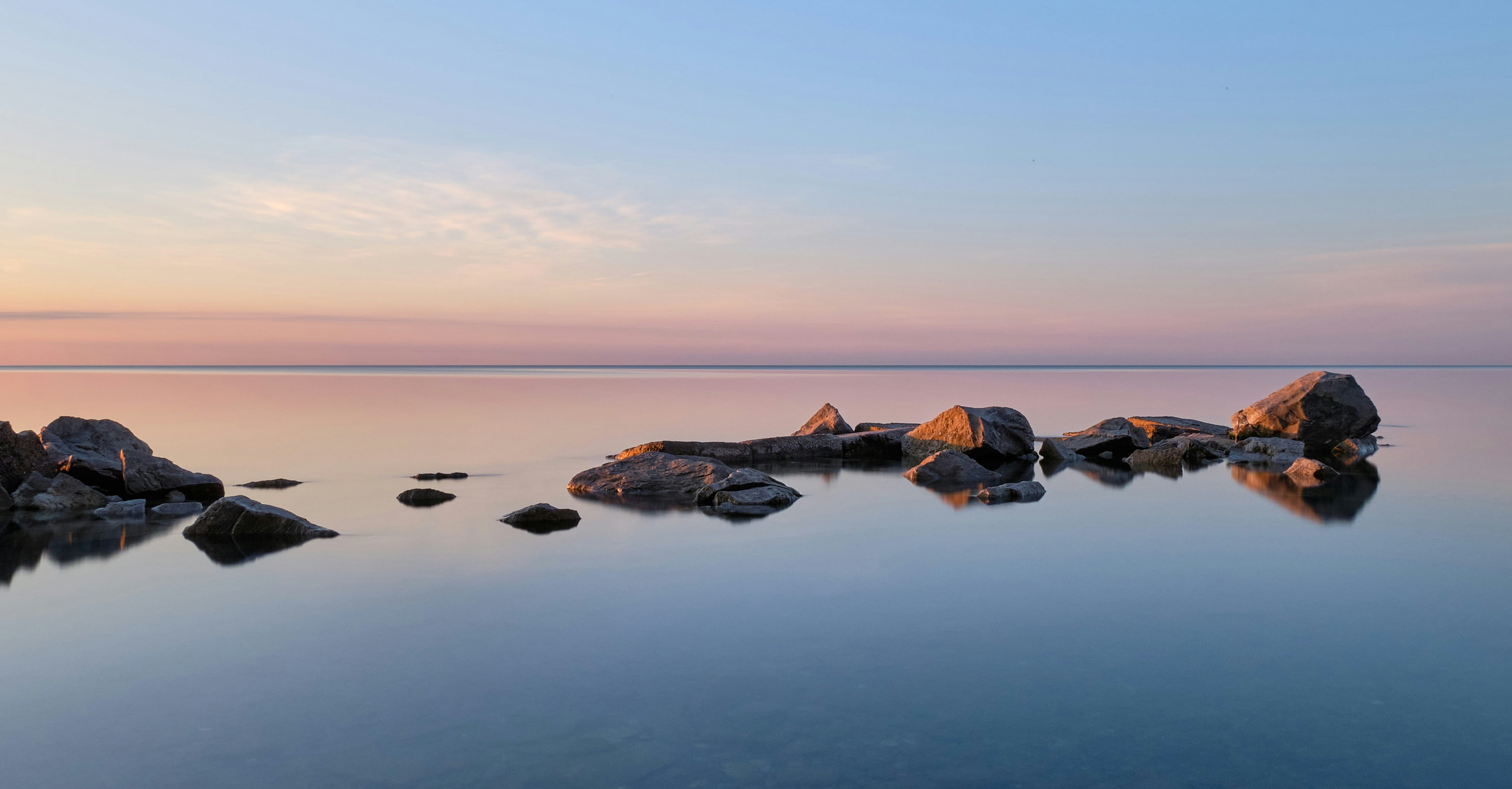 Quiet Horizon: A Calm Sea Framed by Rugged Rocks