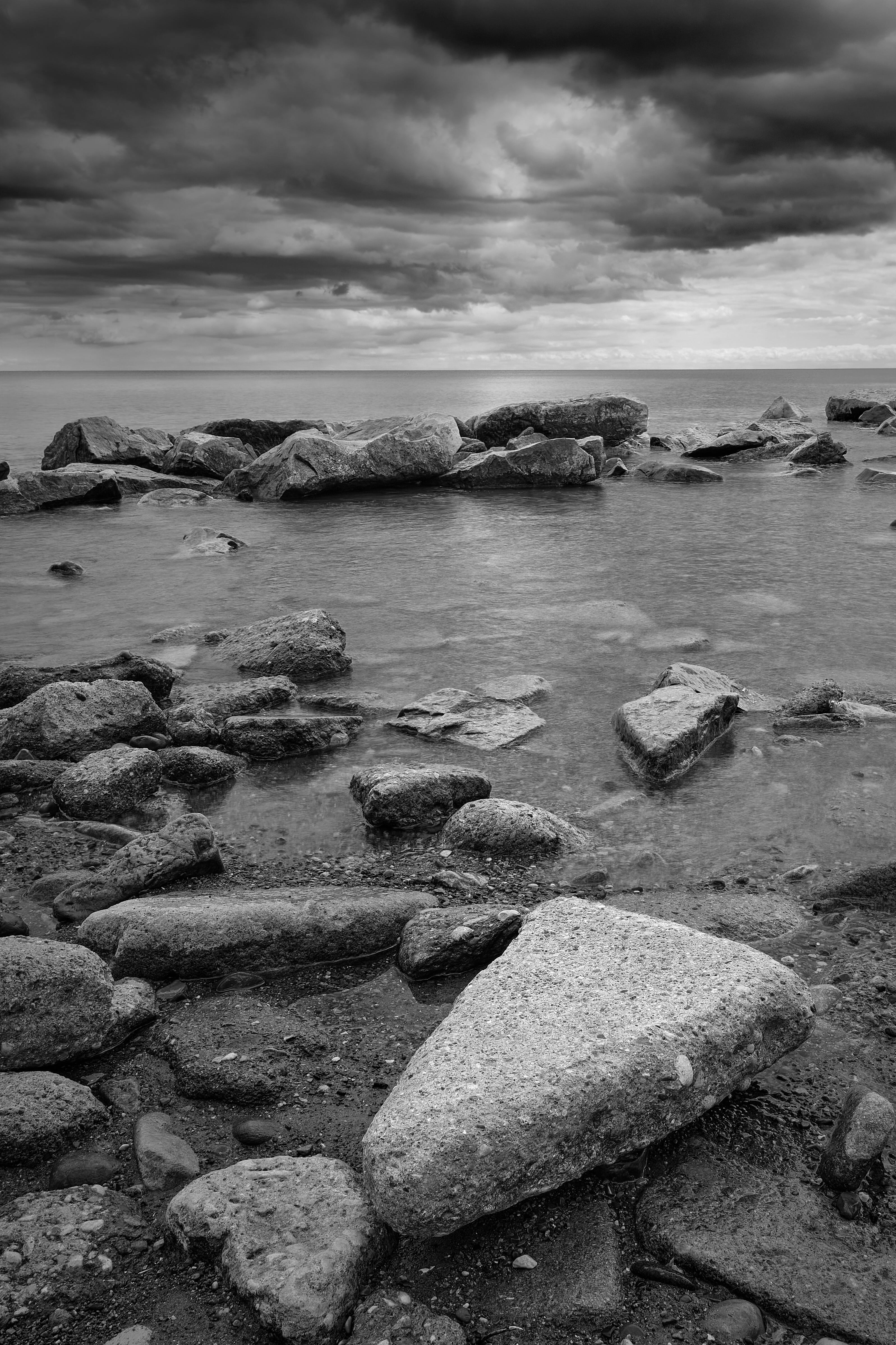 Stony shoreline under brooding skies