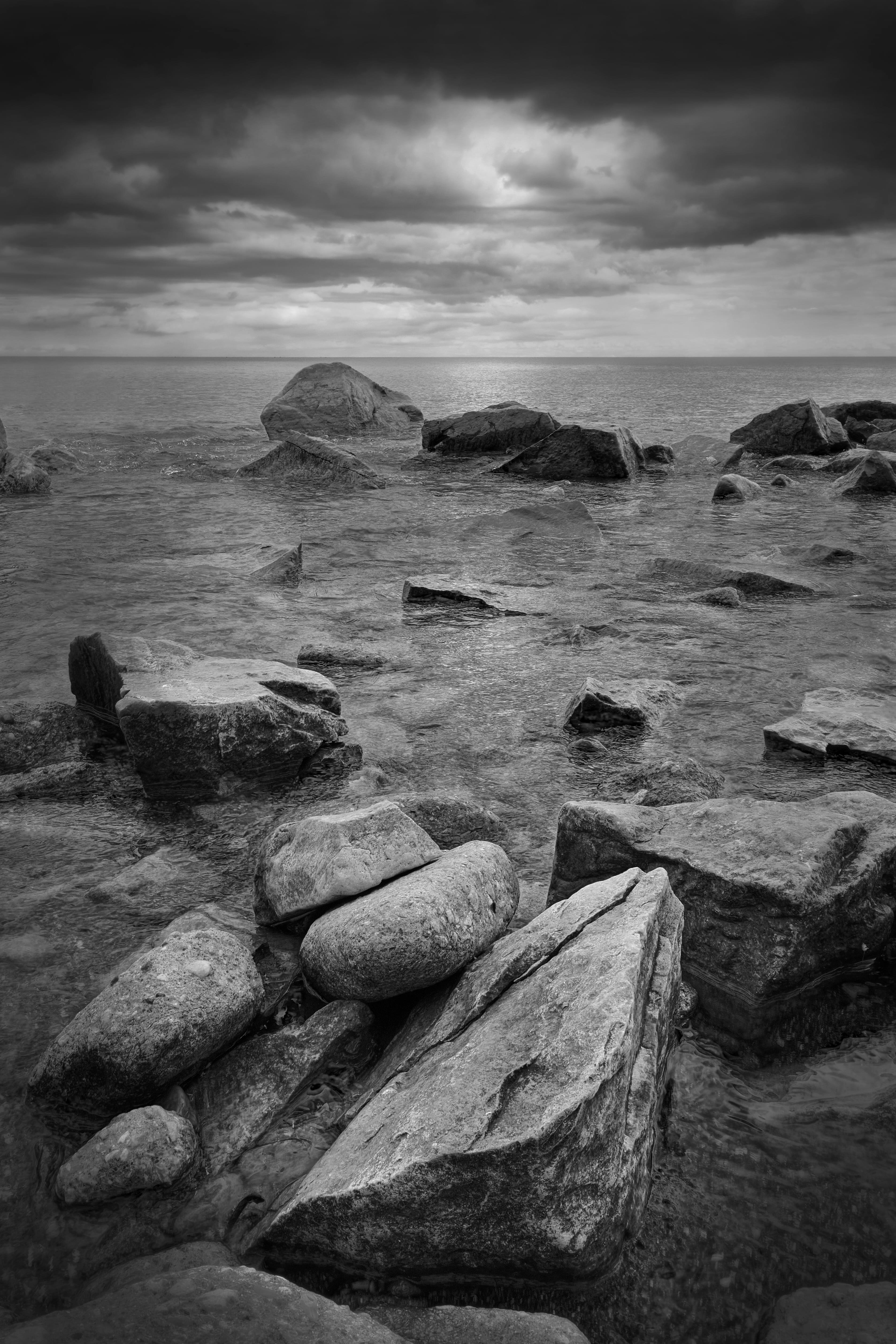 Rugged coastal stones beneath a moody sky