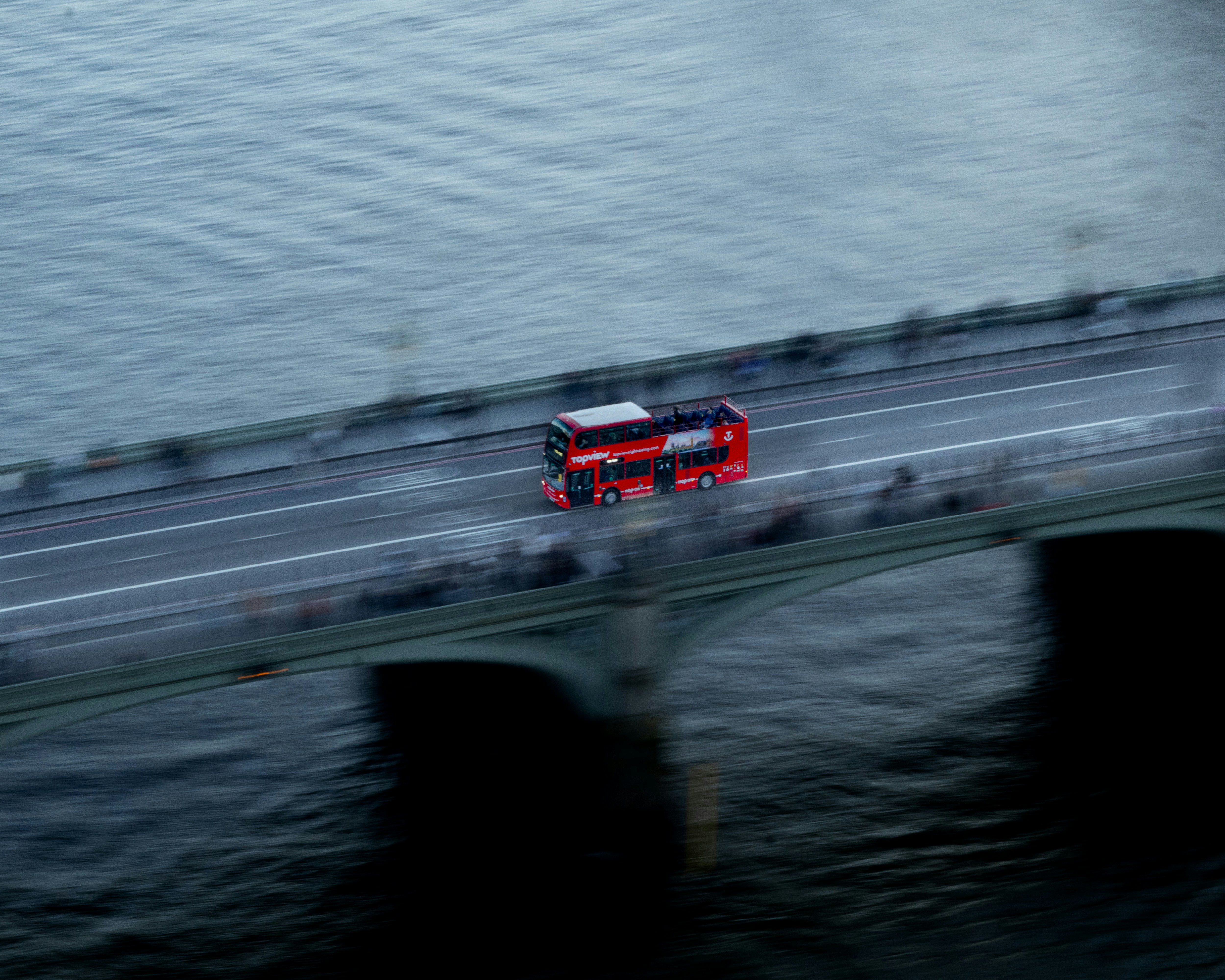 Red City Bus in a Sliver of Motion over the River