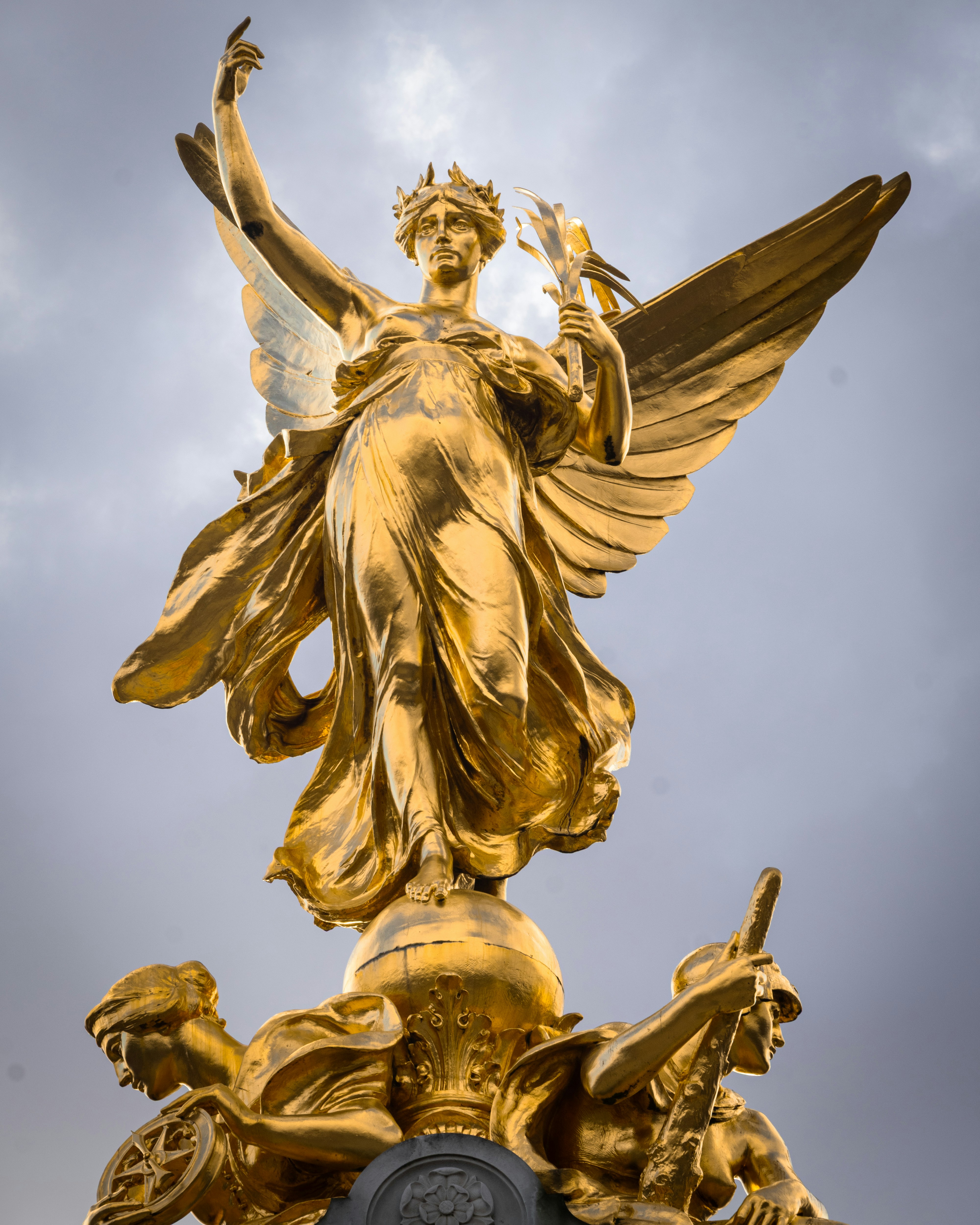 Golden Angel Ascending: A Statue Silhouette Against a Graded Sky