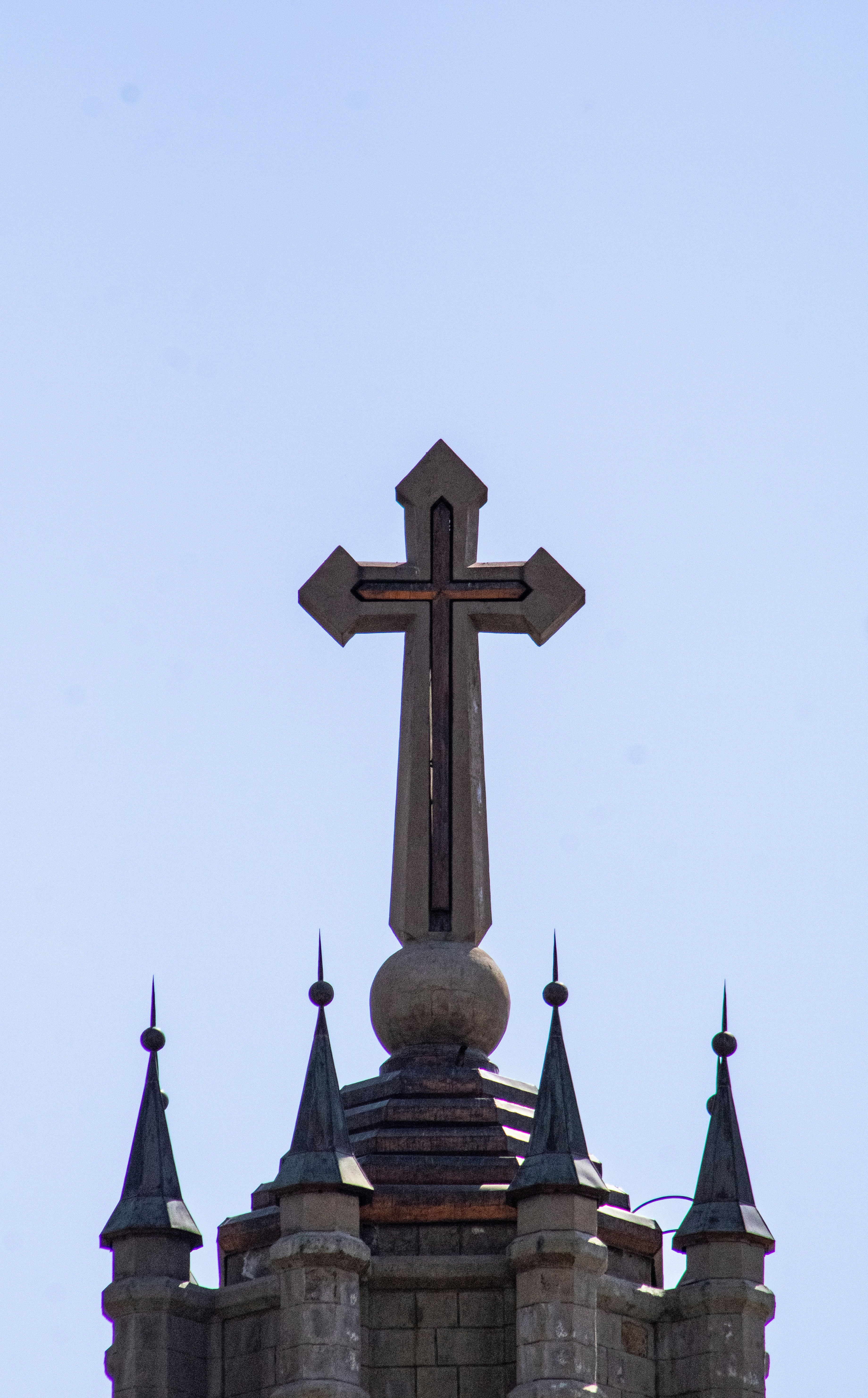 Stone Cross Reaching Toward a Clear Sky