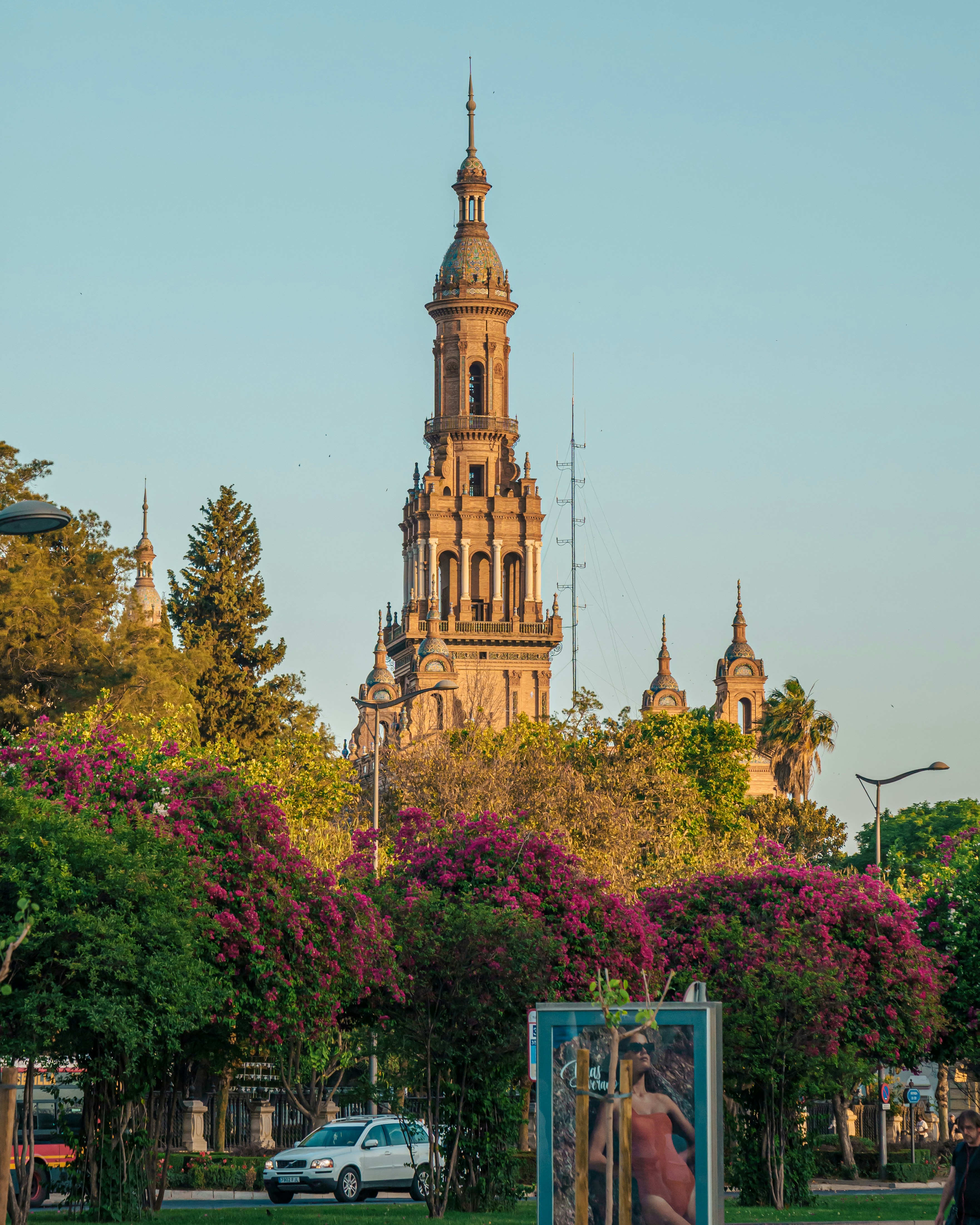 Towering Ornate Spire Framed by Bougainvillea Boulevard
