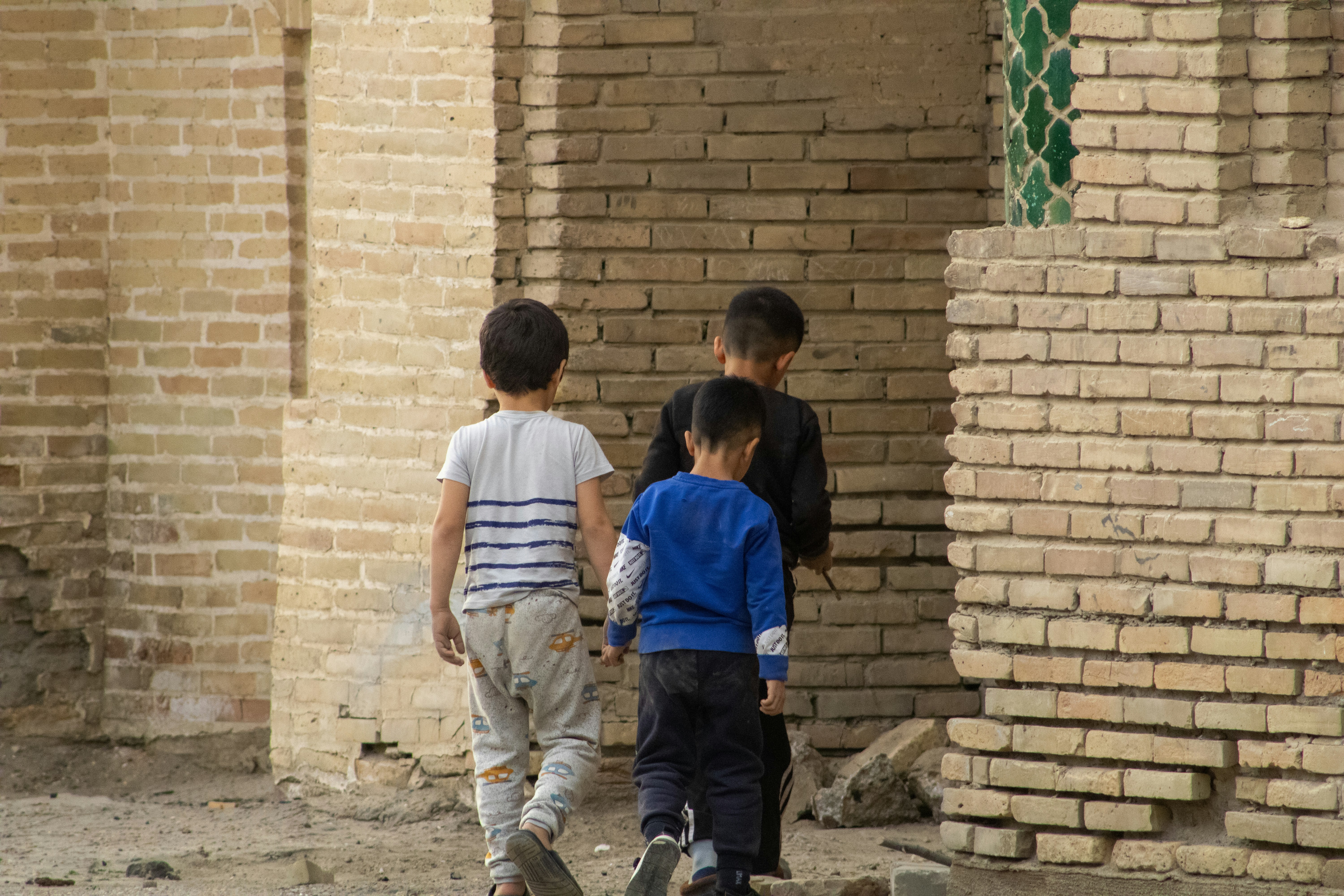 Children Entering a Brick Archway