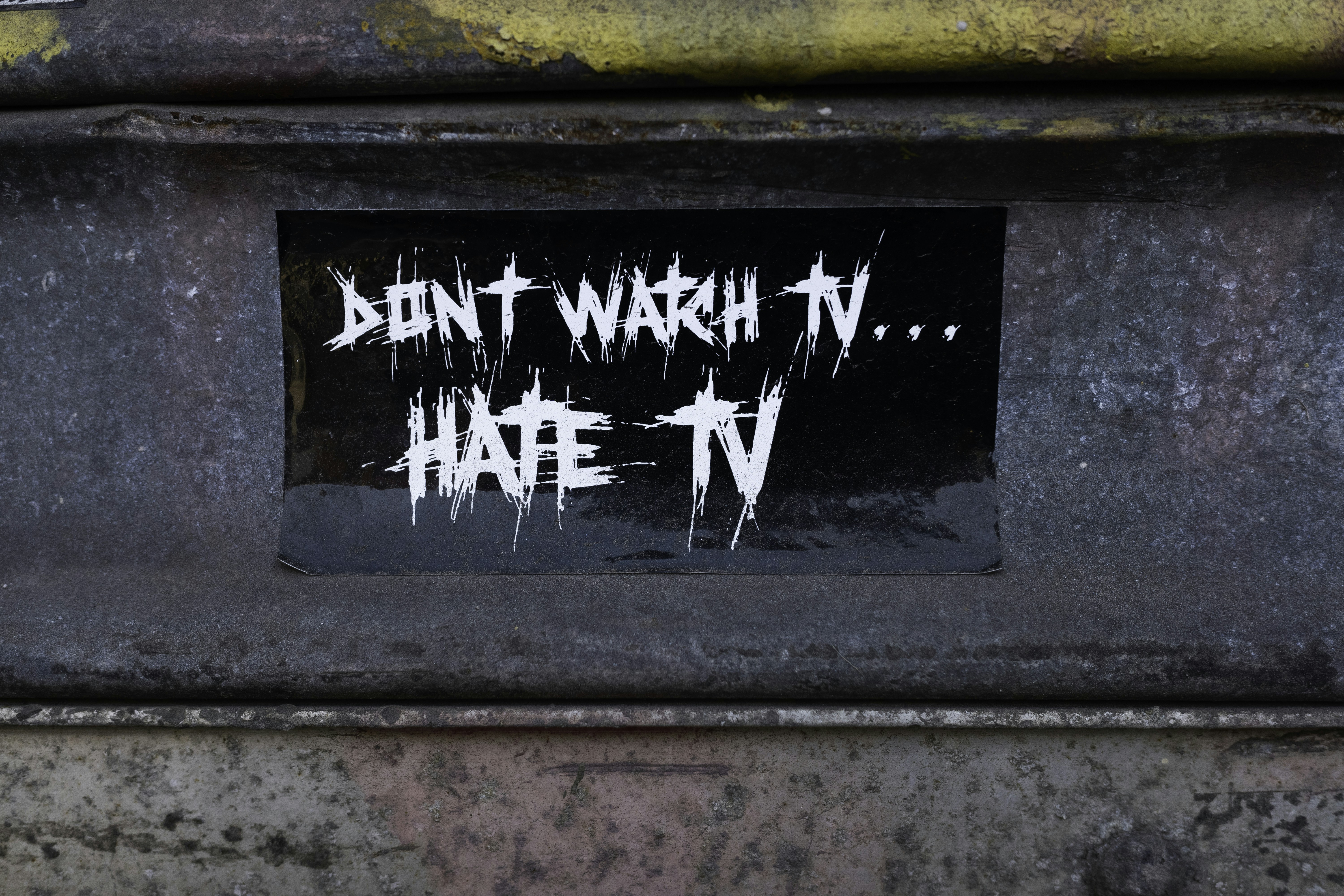 Graffiti Stencil Sticker on Weathered Metal: Don't Wake In, Have TV