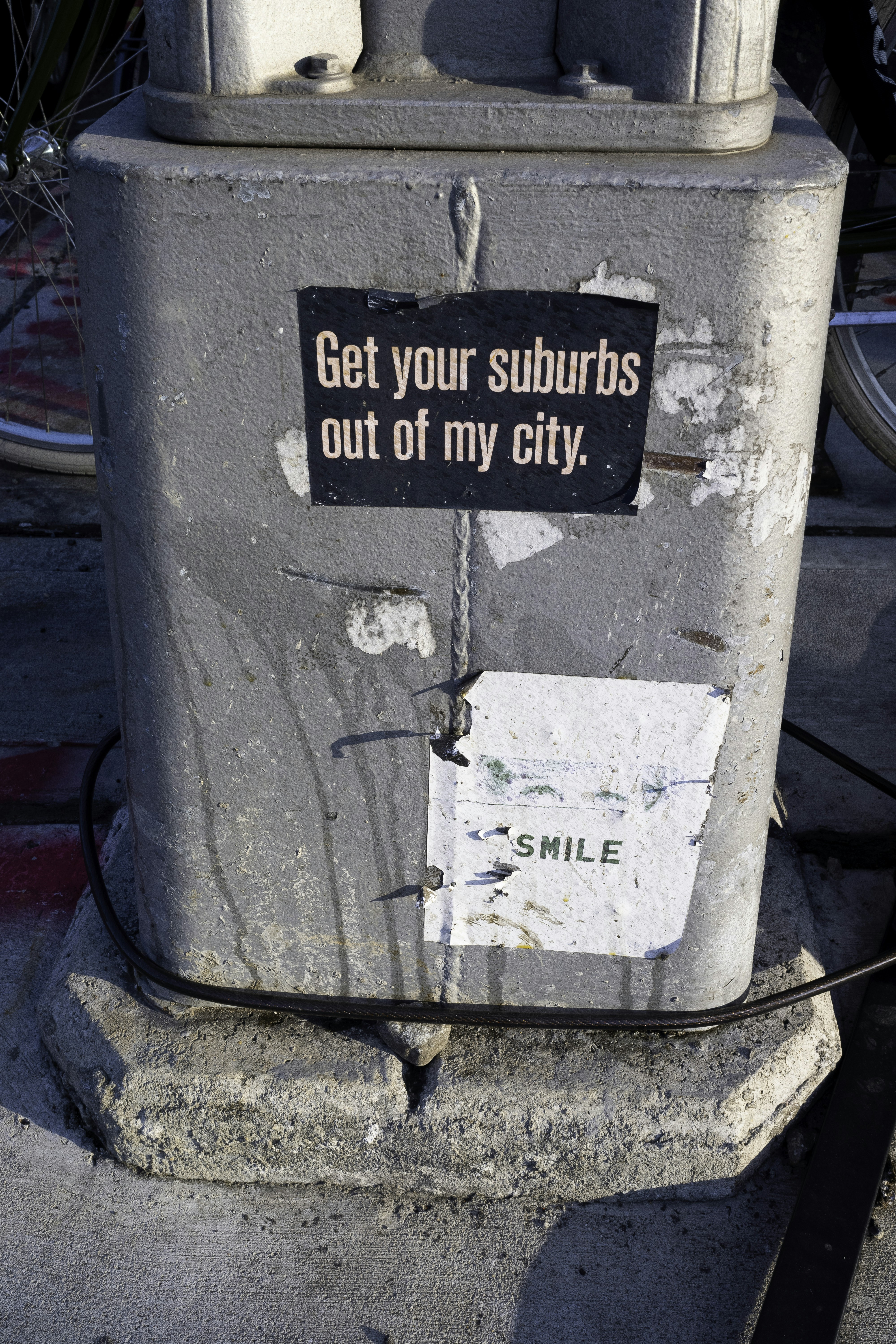 Stickered Utility Column: A Message and a Smile on the City Street