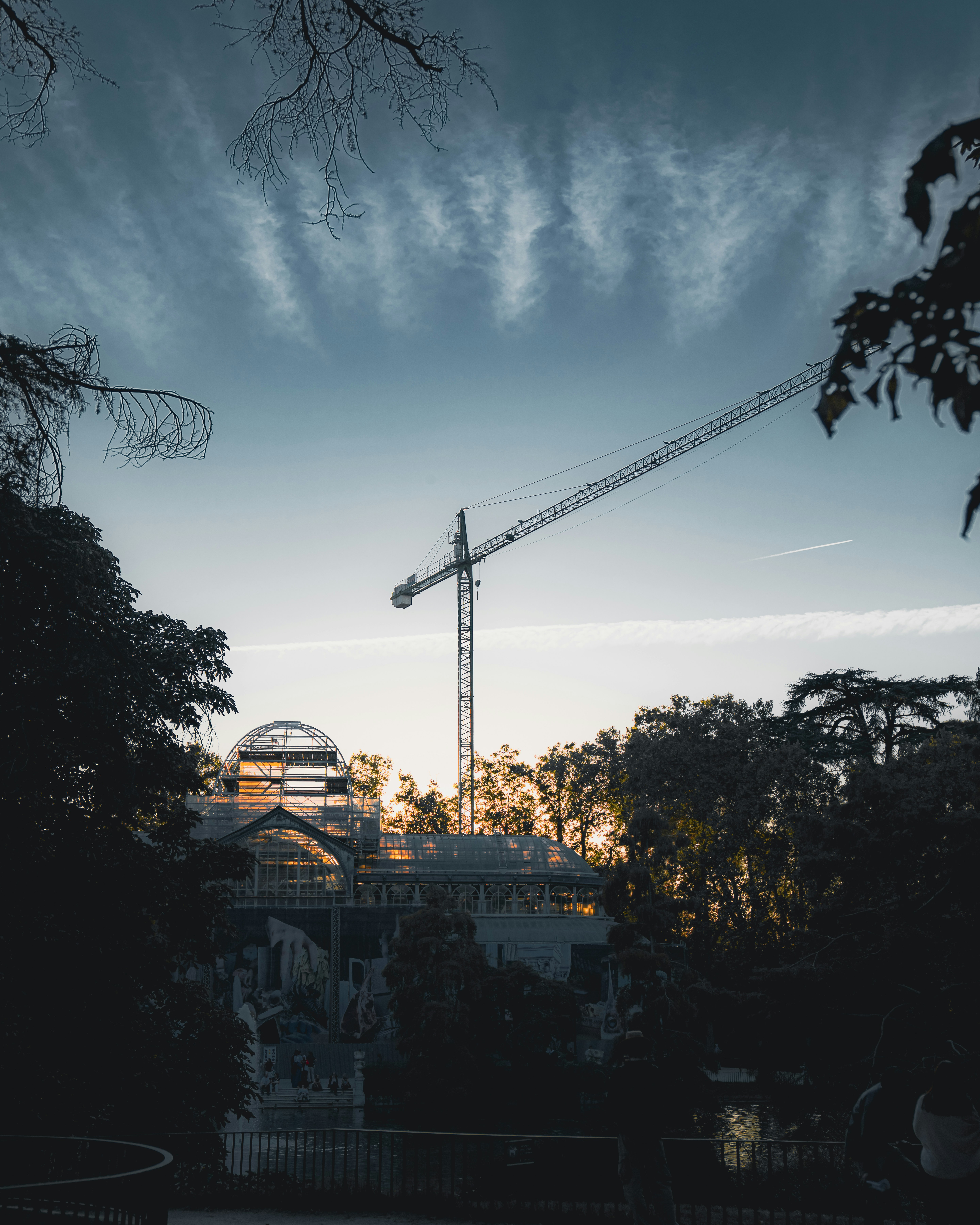Dusk Over the Dome: Construction Crane Framing a City Park