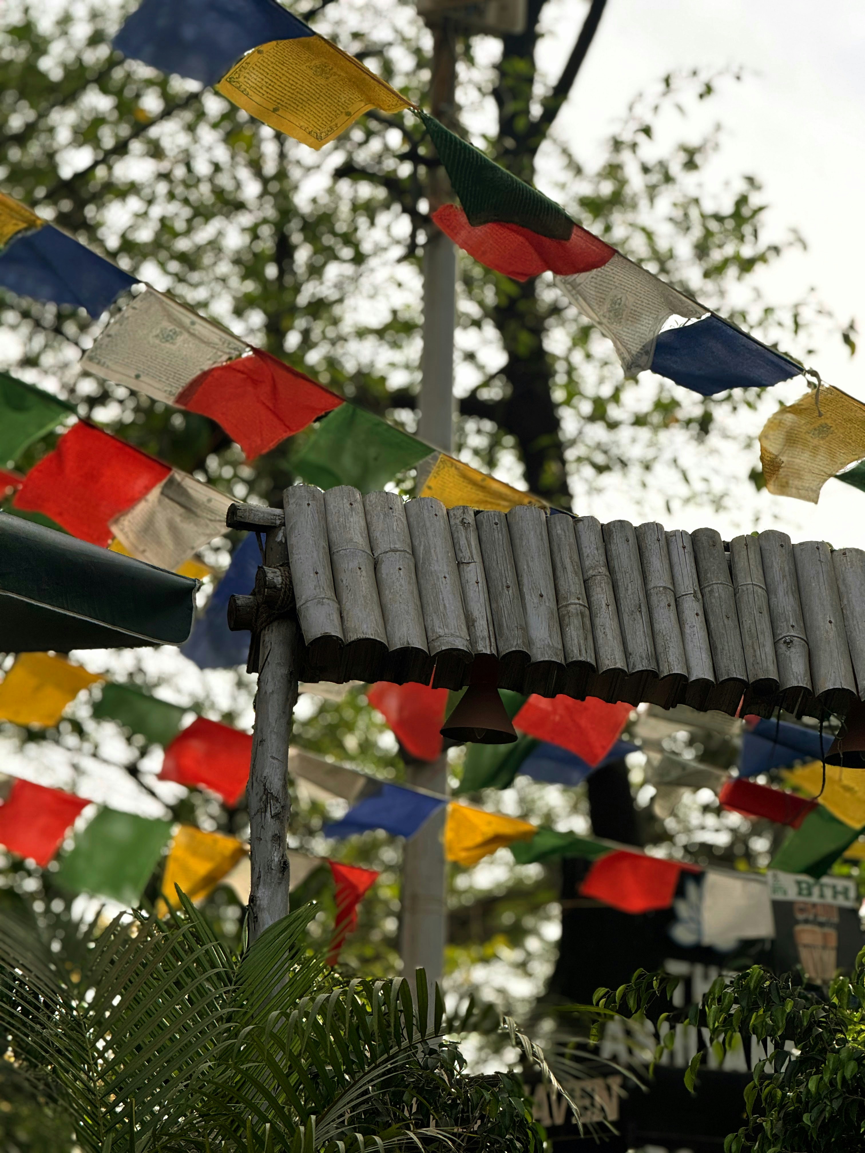 Prayer Flags Above a Weathered Wooden Shelter