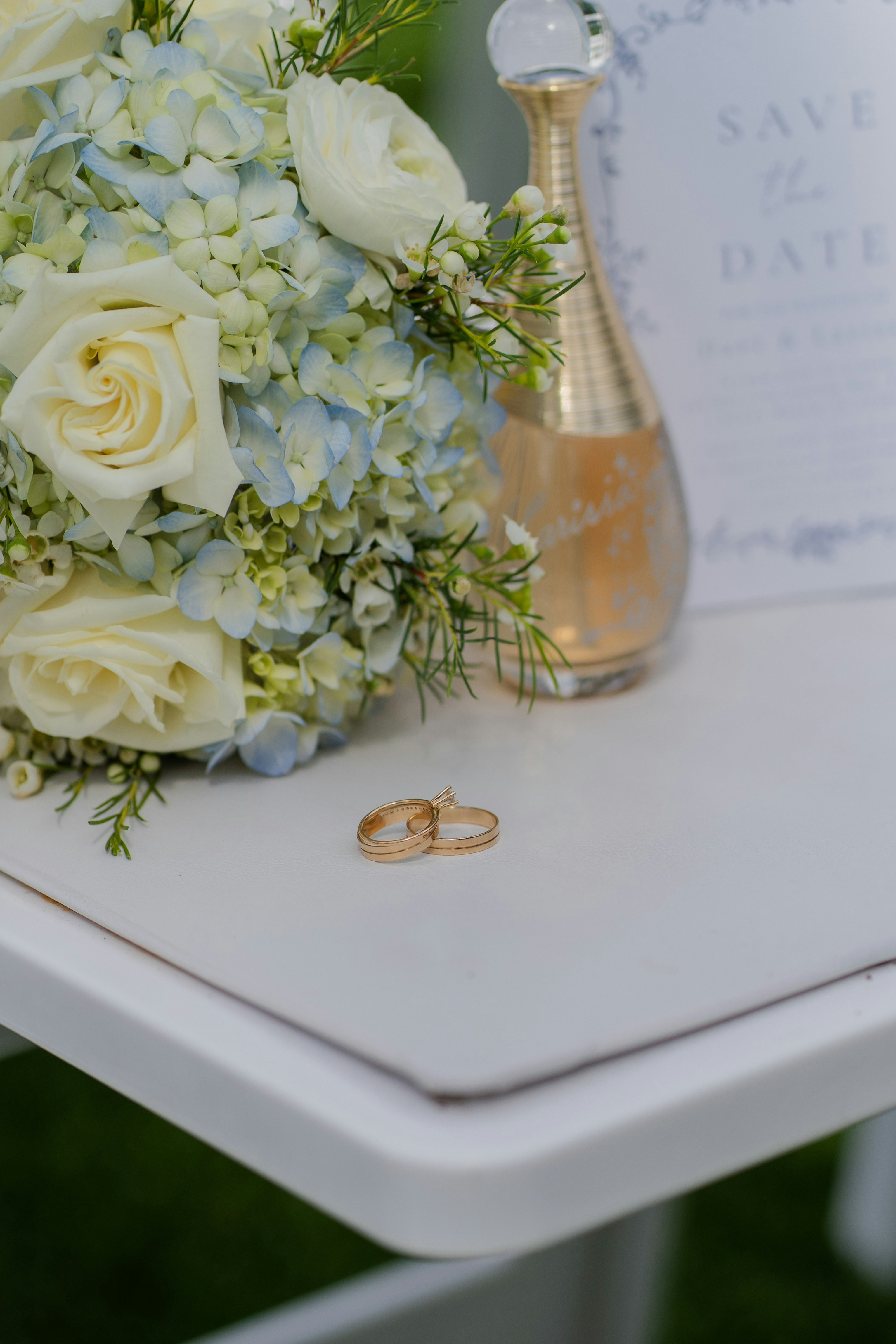 Wedding Bouquet and Rings: Quiet Moment on a White Table
