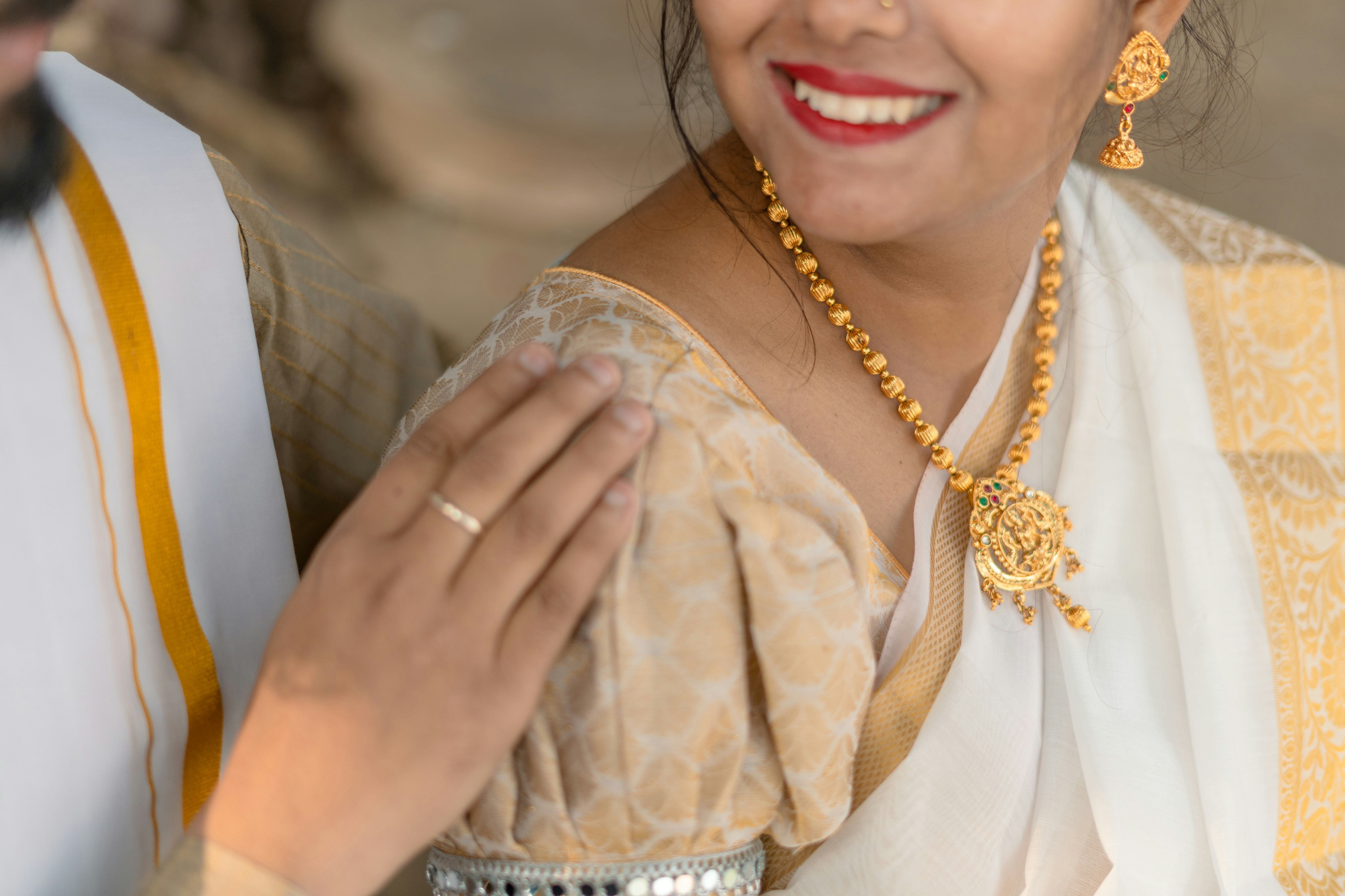 Ceremonial Touch: A Tender Moment in Golden Attire
